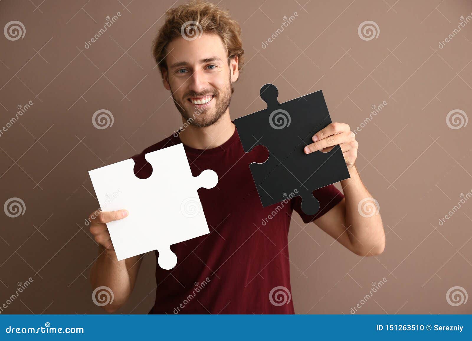 Young Man with Pieces of Jigsaw Puzzle on Color Background Stock Photo ...