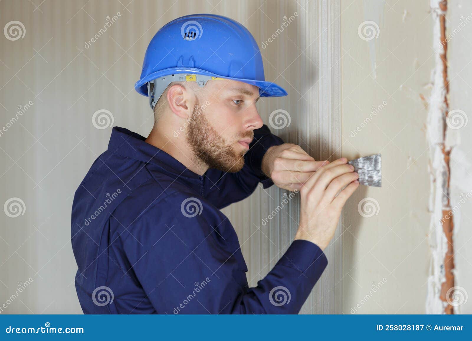 Young man plastering walls stock image. Image of curly - 258028187