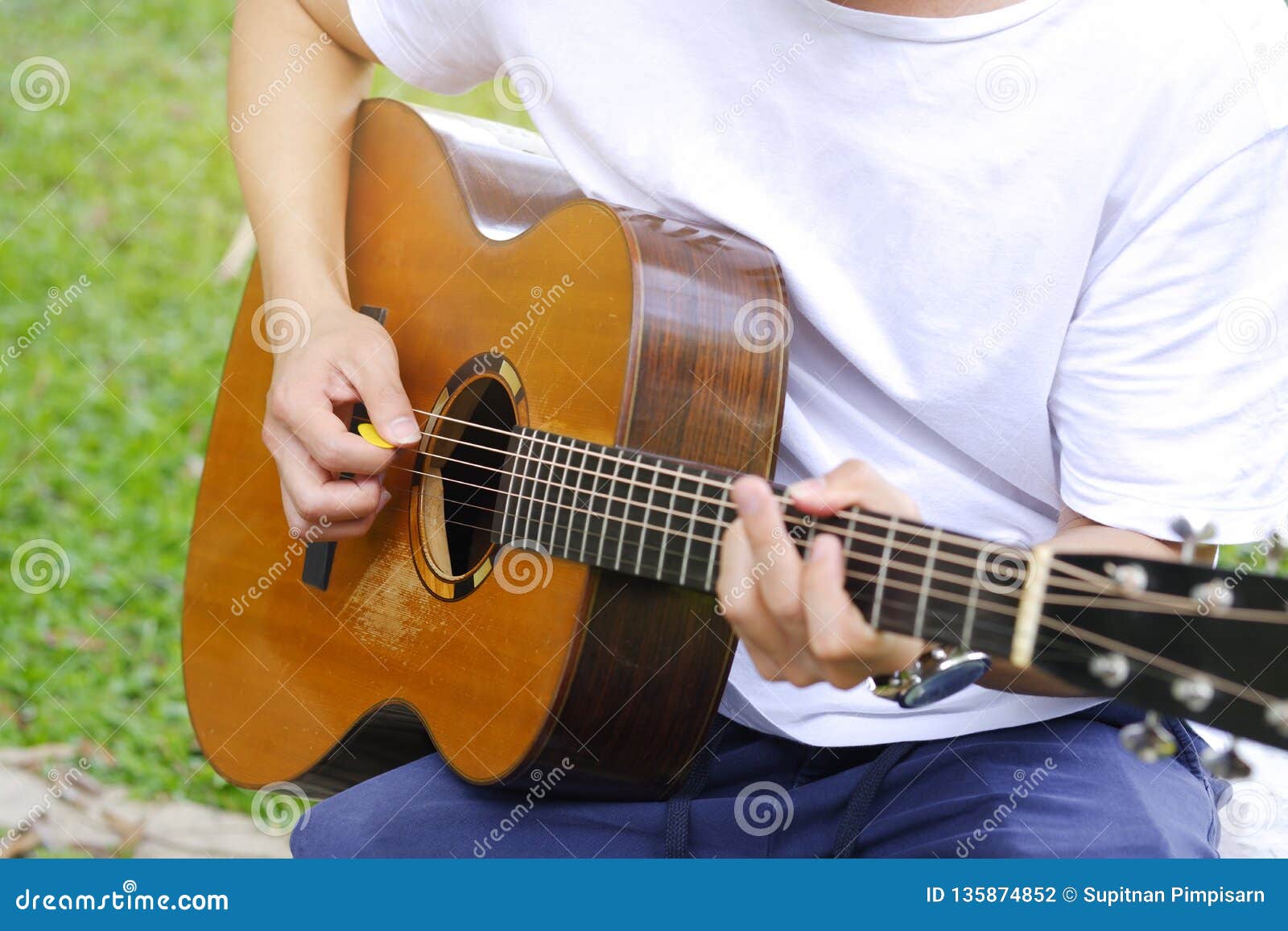 Young Man Playing Acoustic Guitar in the Garden. Stock Photo - Image of ...