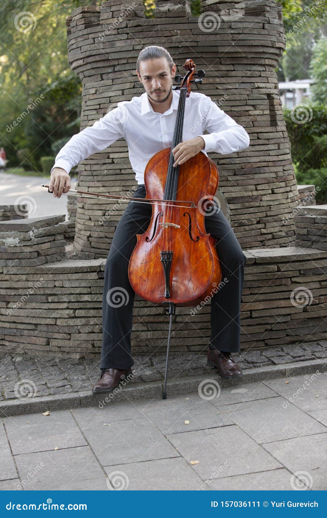 Young Man Playing Cello Outside. Cellist Playing Classical Music on ...