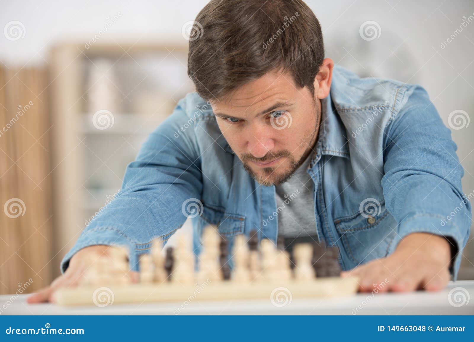 Young man playing chess stock photo. Image of concentration - 149663048