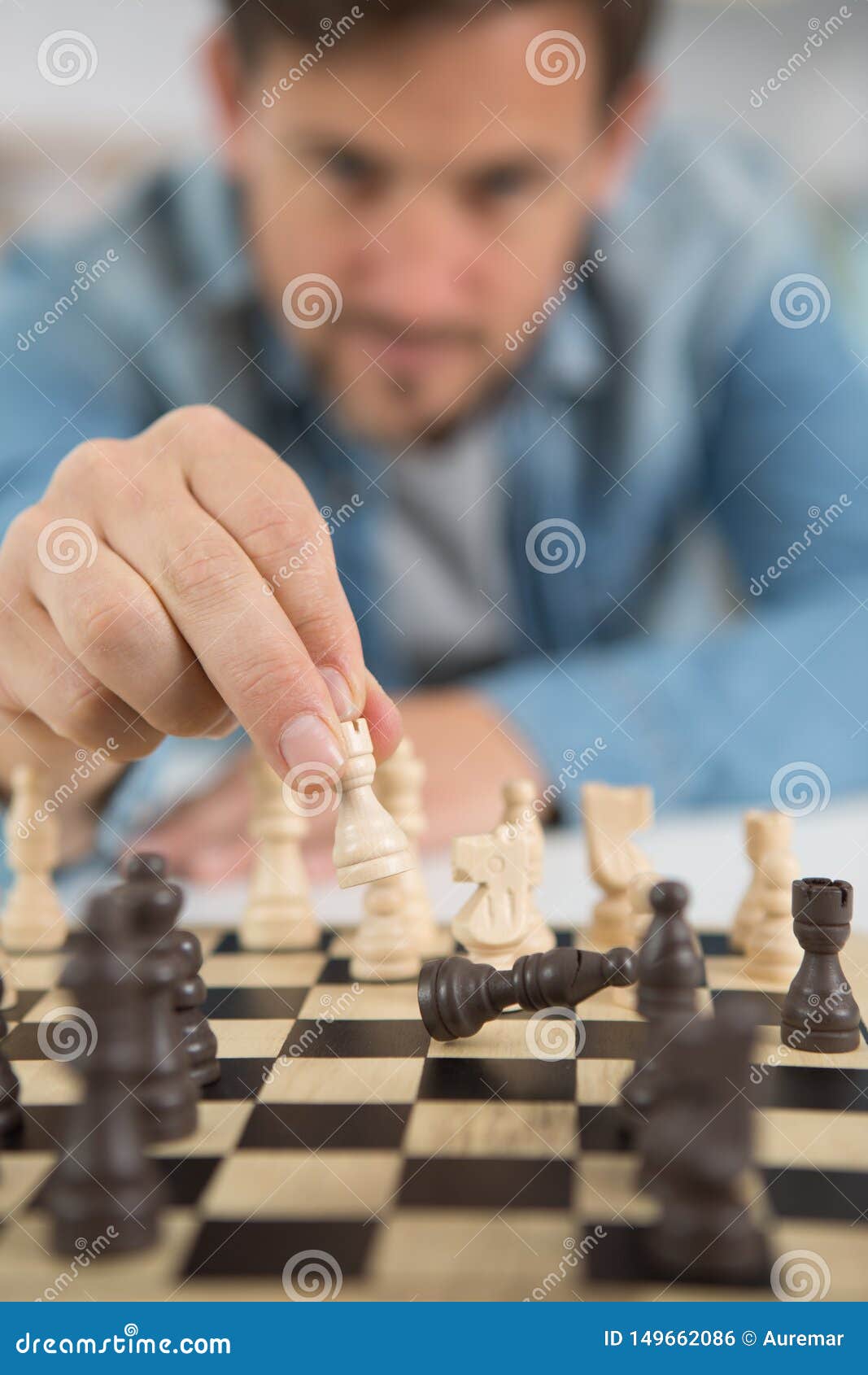 Young man playing chess stock photo. Image of chessboard - 149662086