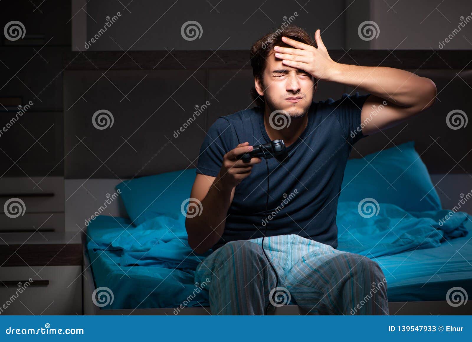 The Young Man Playing Computer Games at Night in Bed Stock Image ...