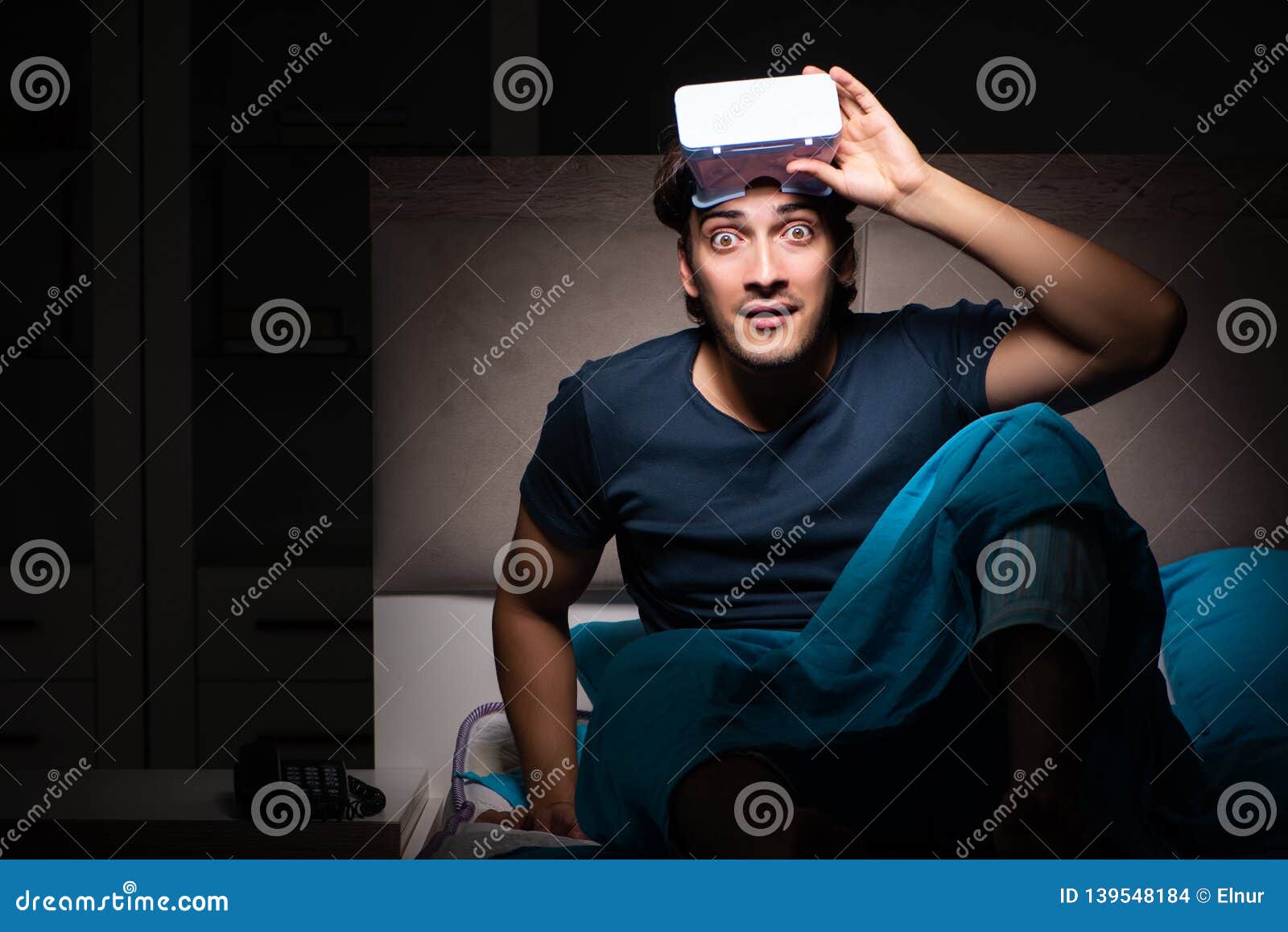 The Young Man Playing Computer Games at Night in Bed Stock Photo ...