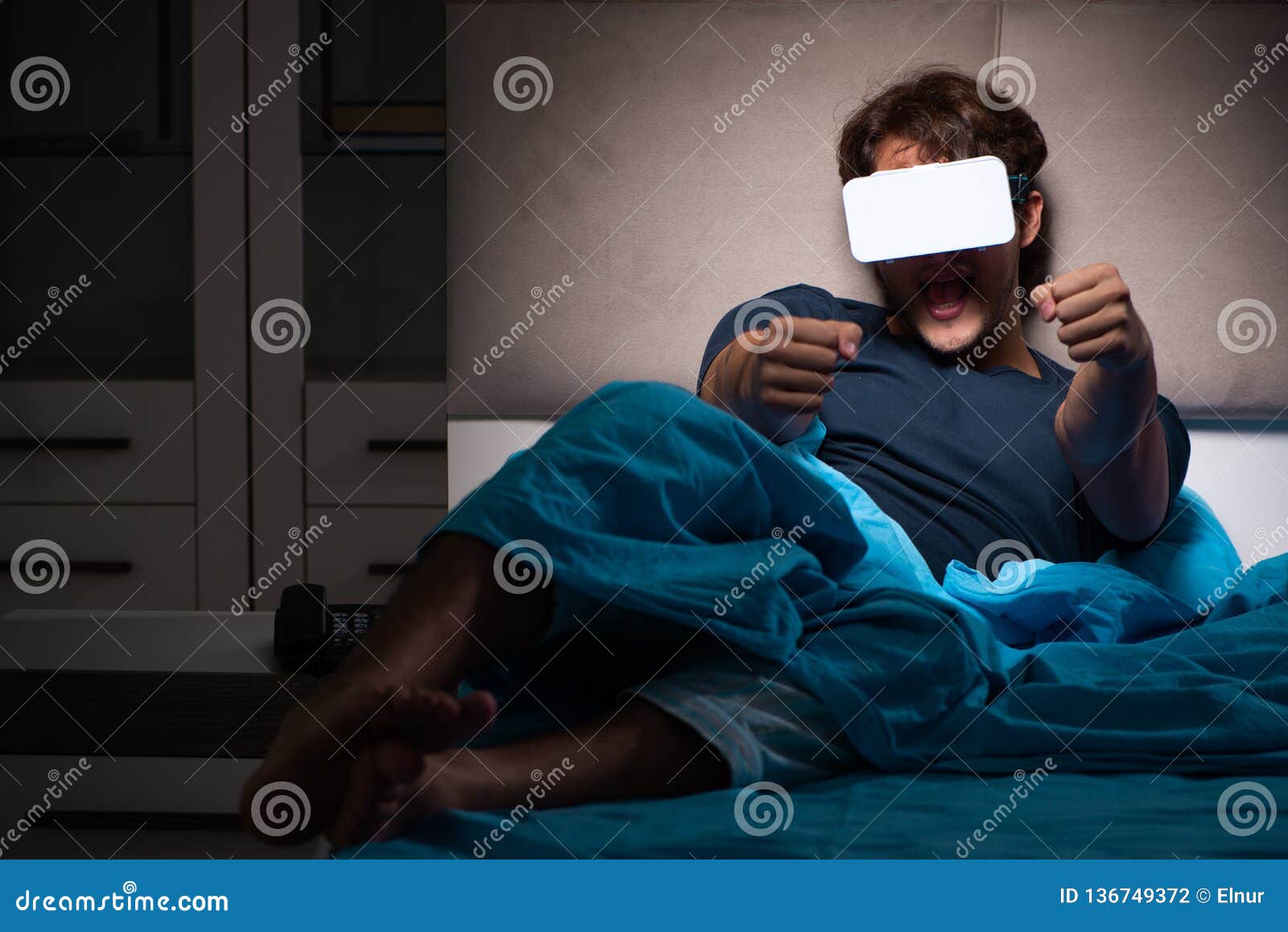 The Young Man Playing Computer Games at Night in Bed Stock Photo ...