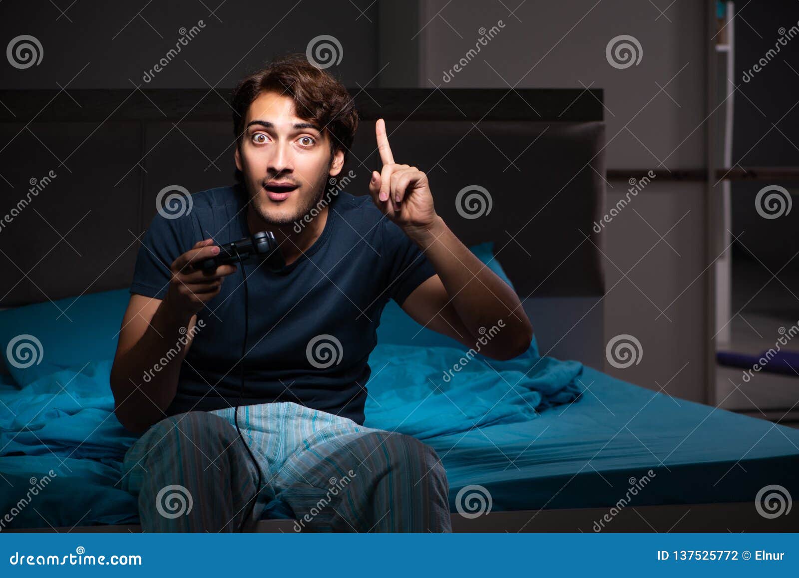 The Young Man Playing Computer Games at Night in Bed Stock Photo ...