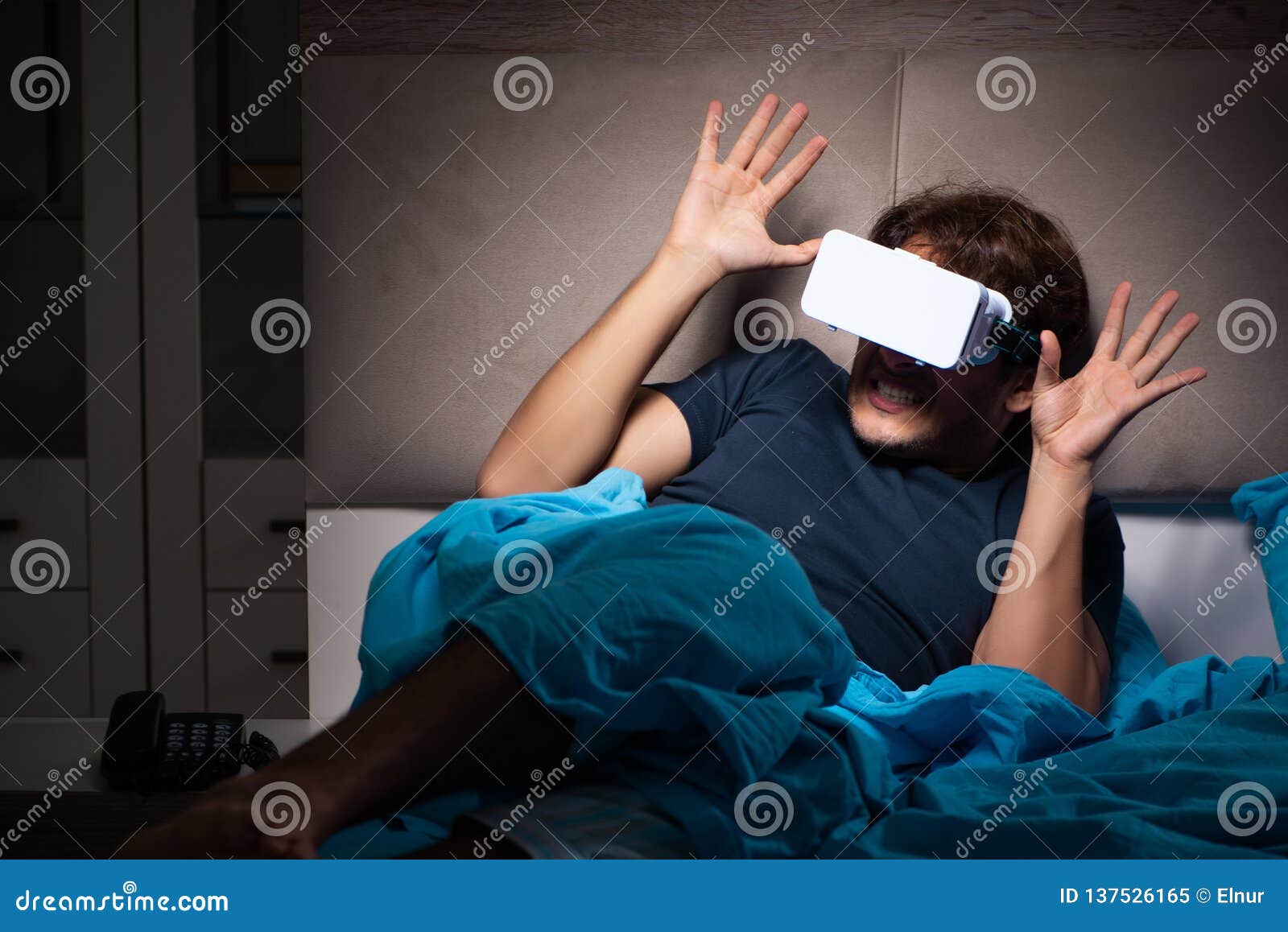 The Young Man Playing Computer Games at Night in Bed Stock Image ...