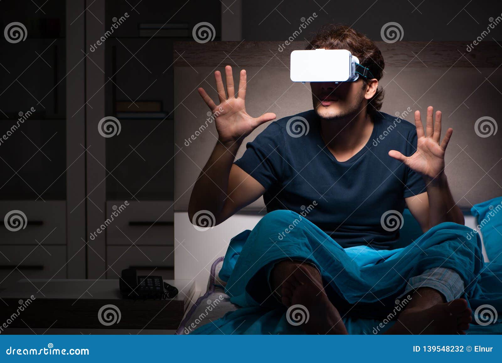 The Young Man Playing Computer Games at Night in Bed Stock Photo ...