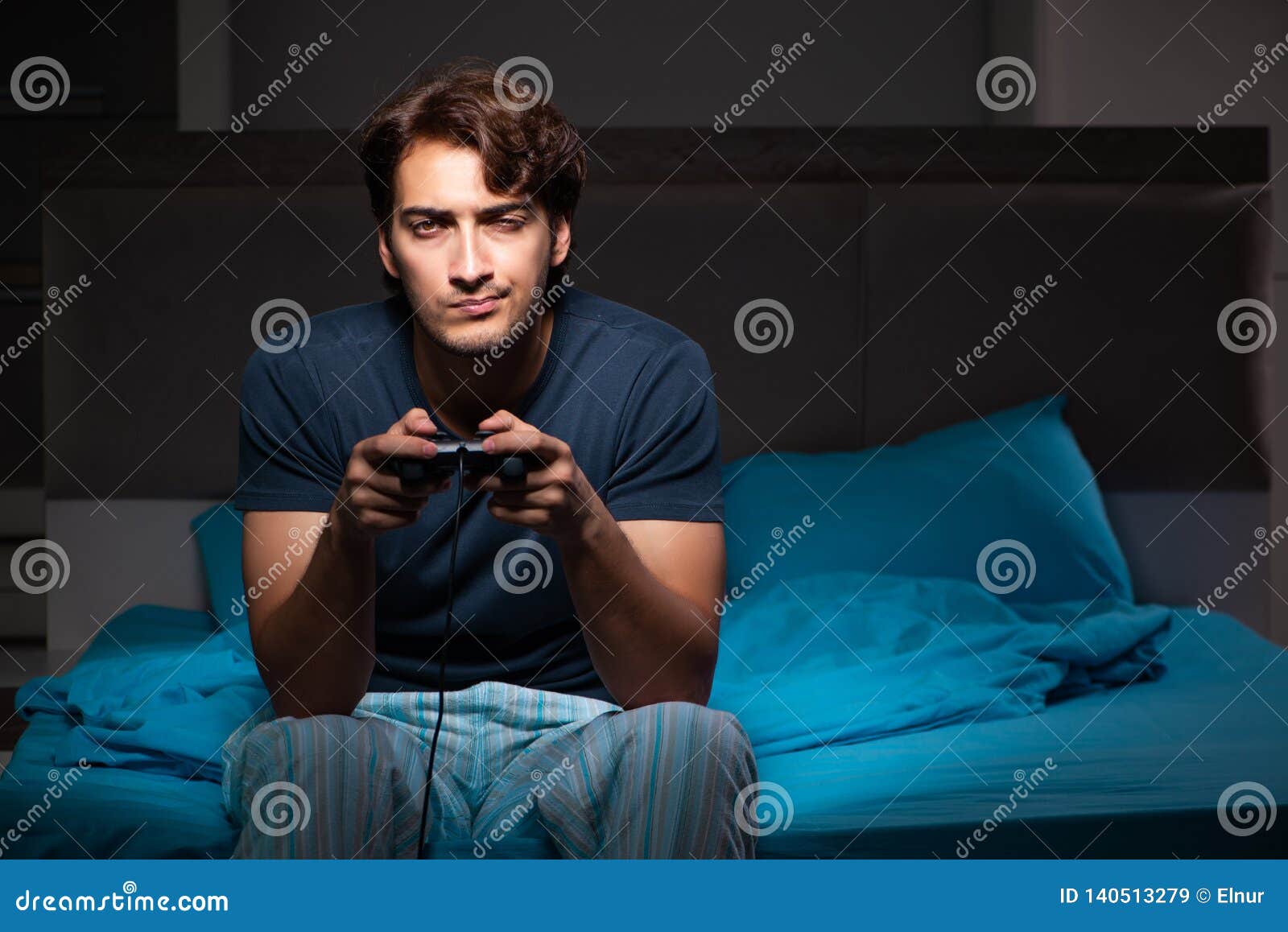 The Young Man Playing Computer Games at Night in Bed Stock Image ...