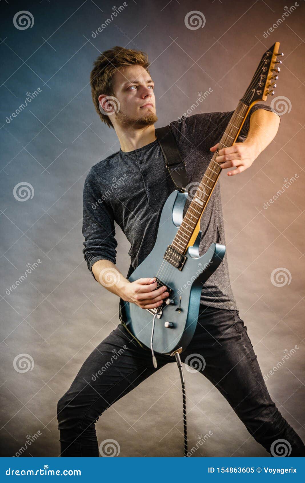 Young Man Playing Electric Guitar Stock Image - Image of strumming ... Young Man Playing Electric Guitar Stock Image - Image of strumming ...