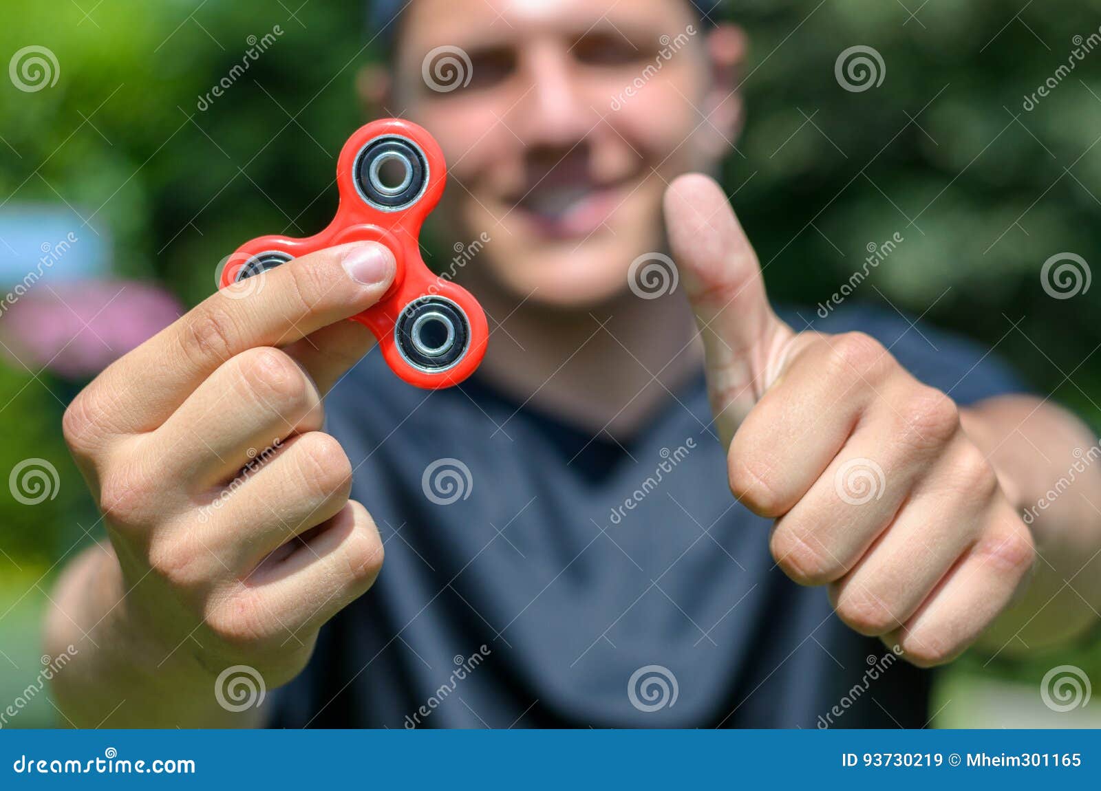 Young Man Playing with a Fidget Spinner Stock Image - Image of ...