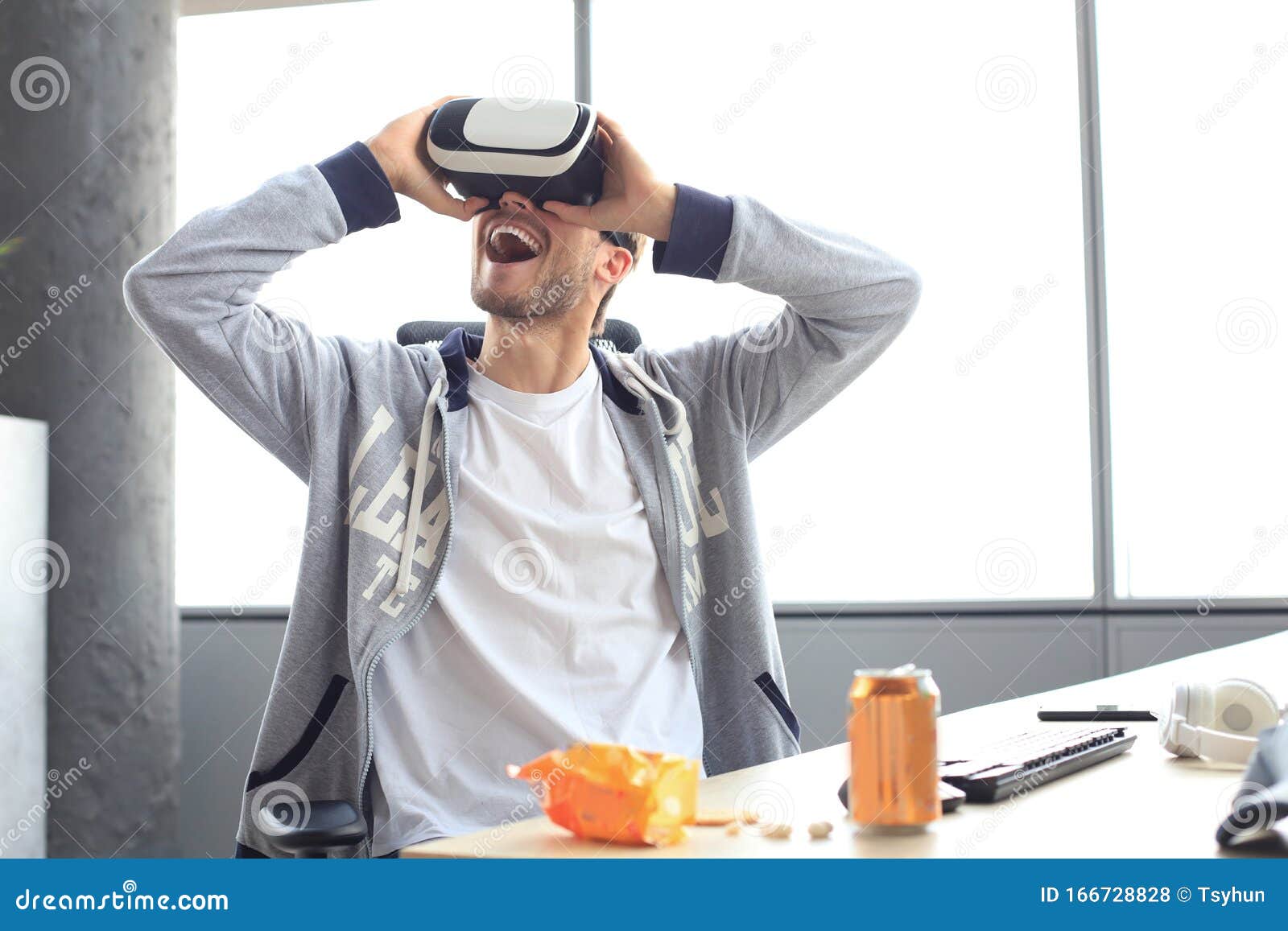 Young Man Playing Game Using Virtual Reality Headset in the Playing ... Young Man Playing Game Using Virtual Reality Headset in the Playing ...