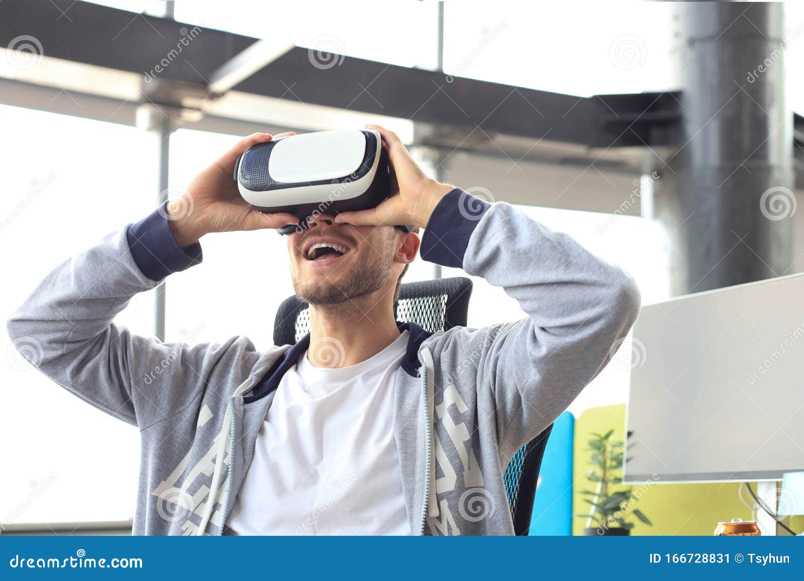 Young Man Playing Game Using Virtual Reality Headset in the Playing ... Young Man Playing Game Using Virtual Reality Headset in the Playing ...