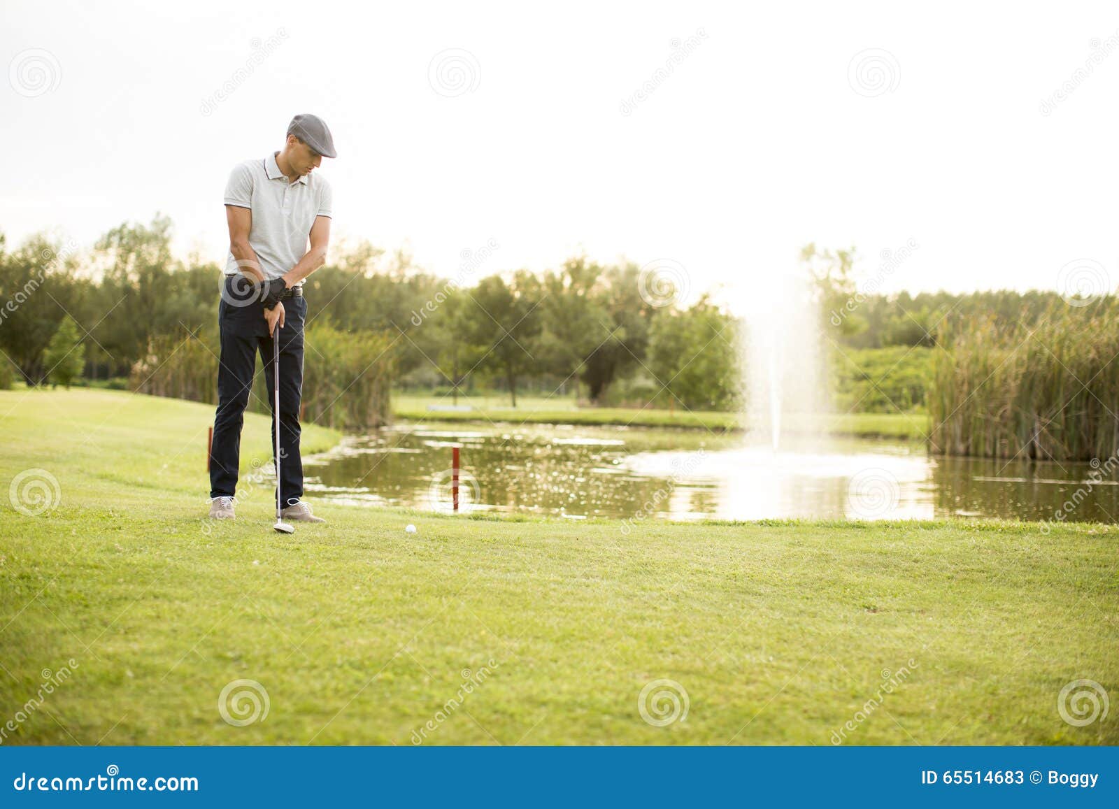 Young man playing golf stock image. Image of outside - 65514683