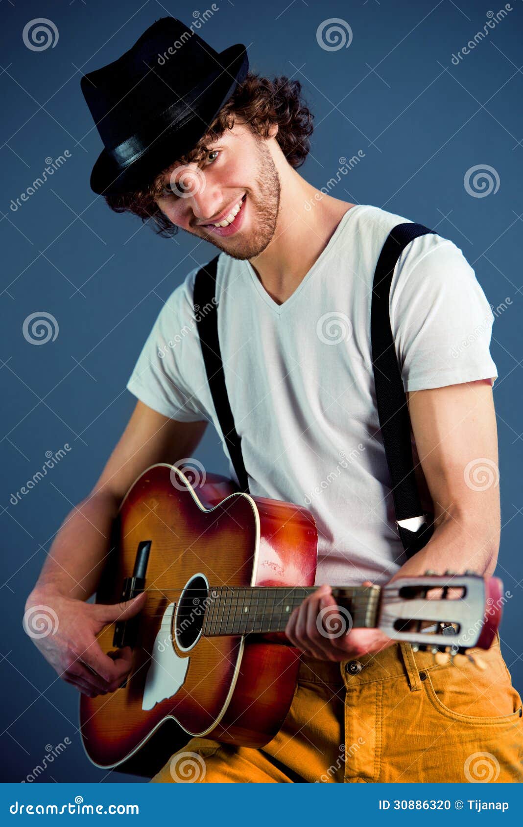Young man playing guitar stock photo. Image of musical - 30886320