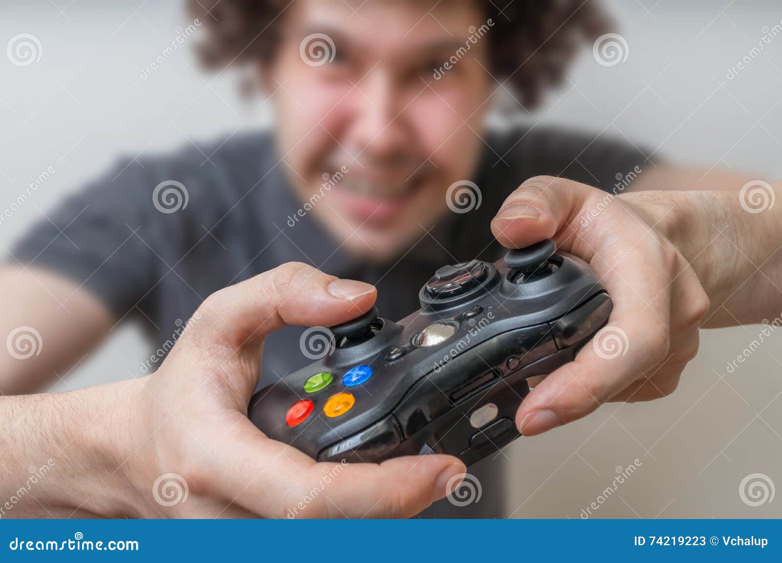 Young Man is Playing Video Games and Holds Joystick or Controller Stock ...