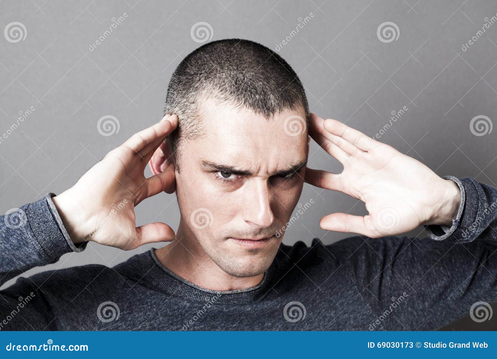 Young Man Plugging Ears To Avoid Listening To Problems Stock Image ...
