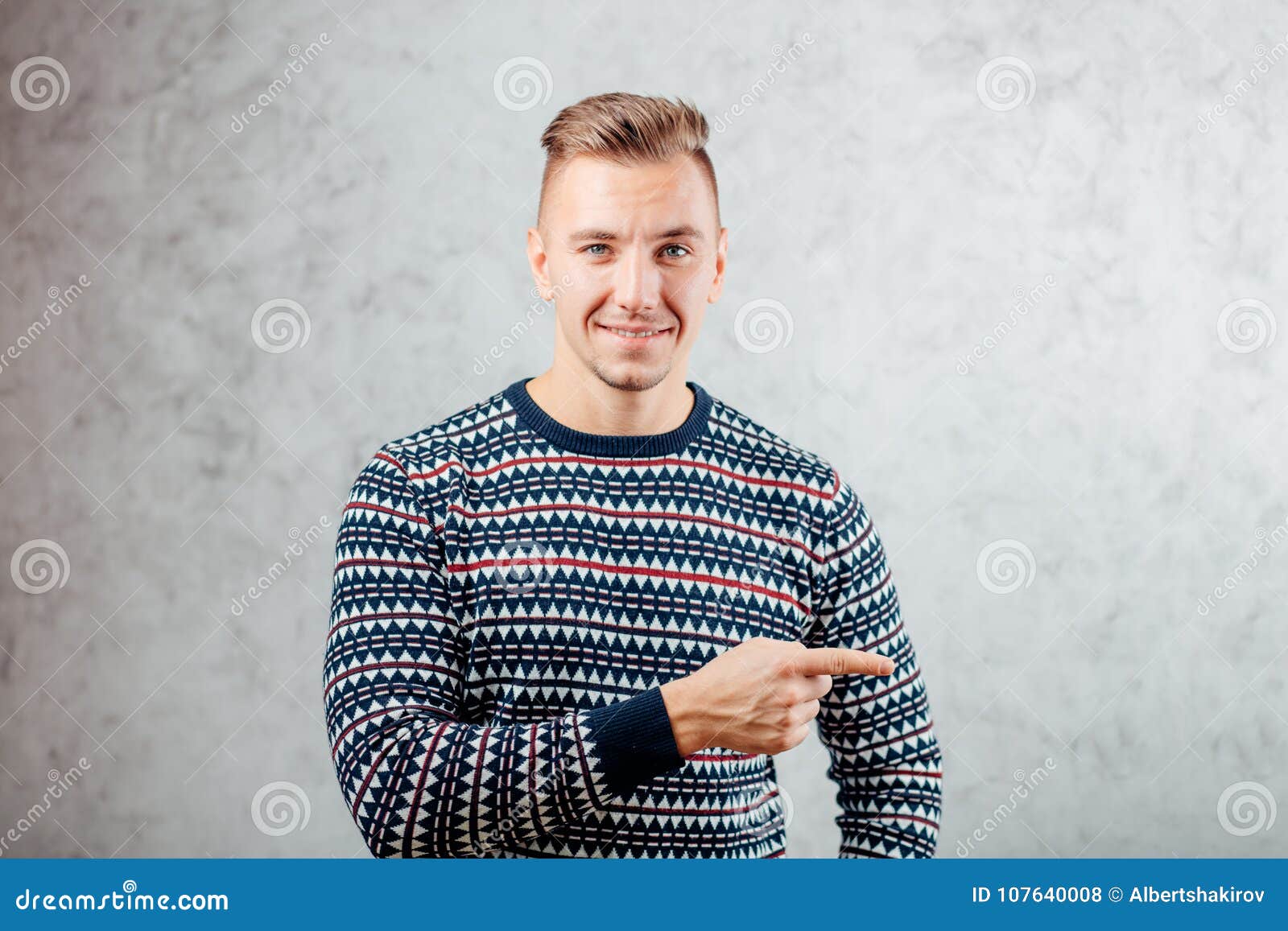 Young Man Pointing Directions on Textured Concrete Wall Background ...