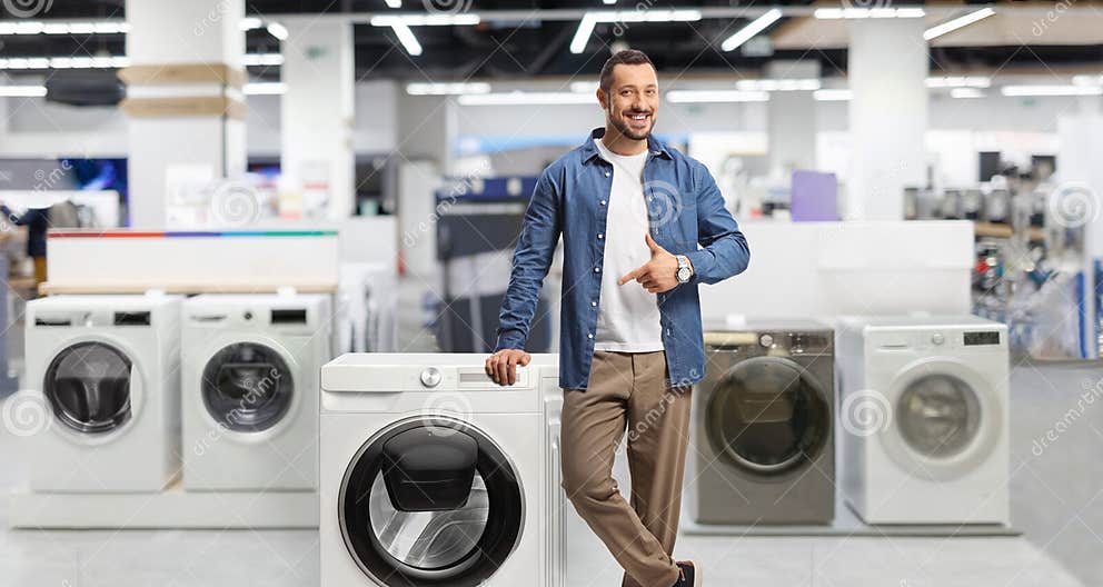 Young Man Pointing at a Washing Machine Stock Image - Image of addwash ...