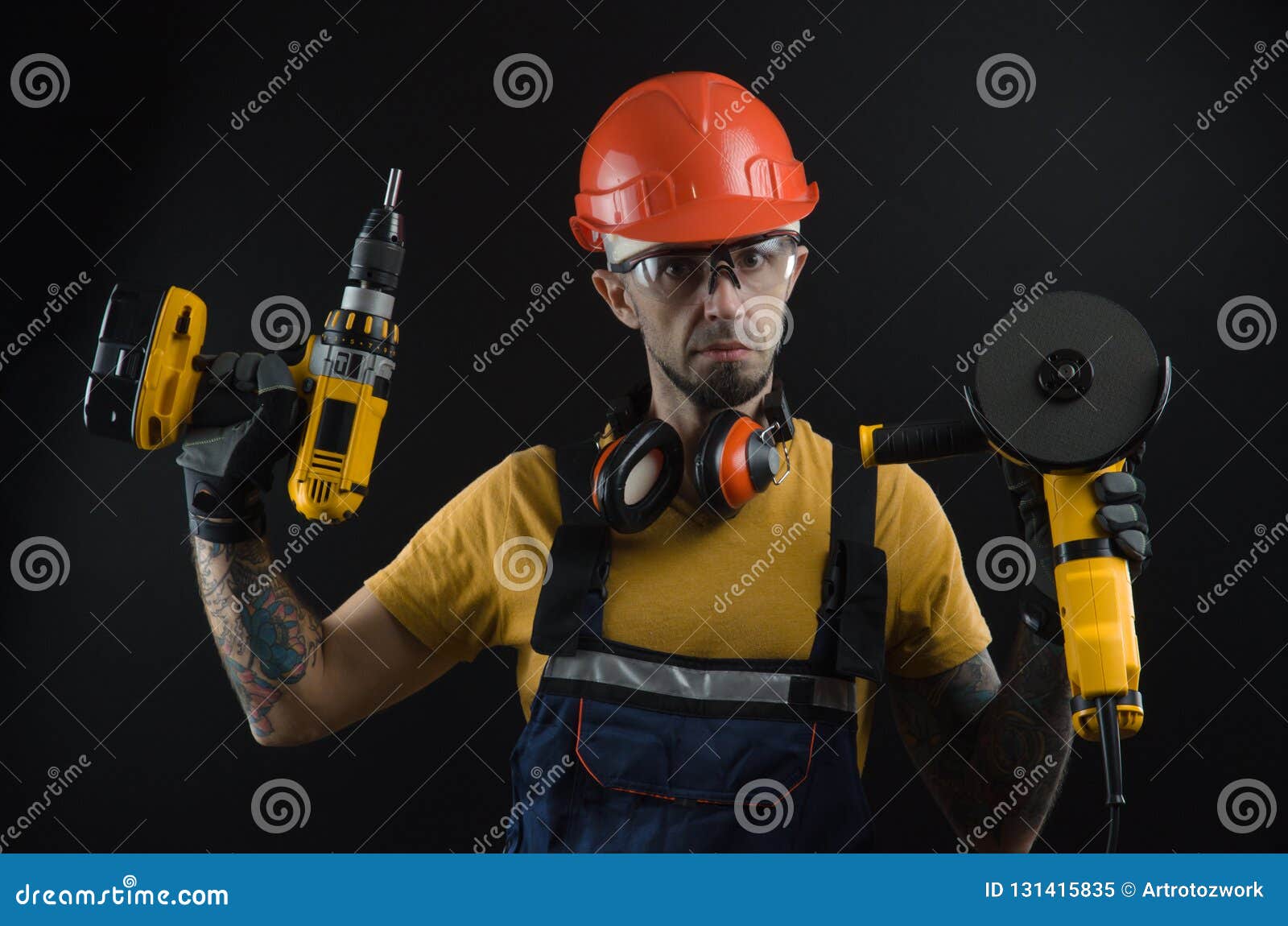 A Young Man Posing on a Black Background in a Work Uniform and a ...