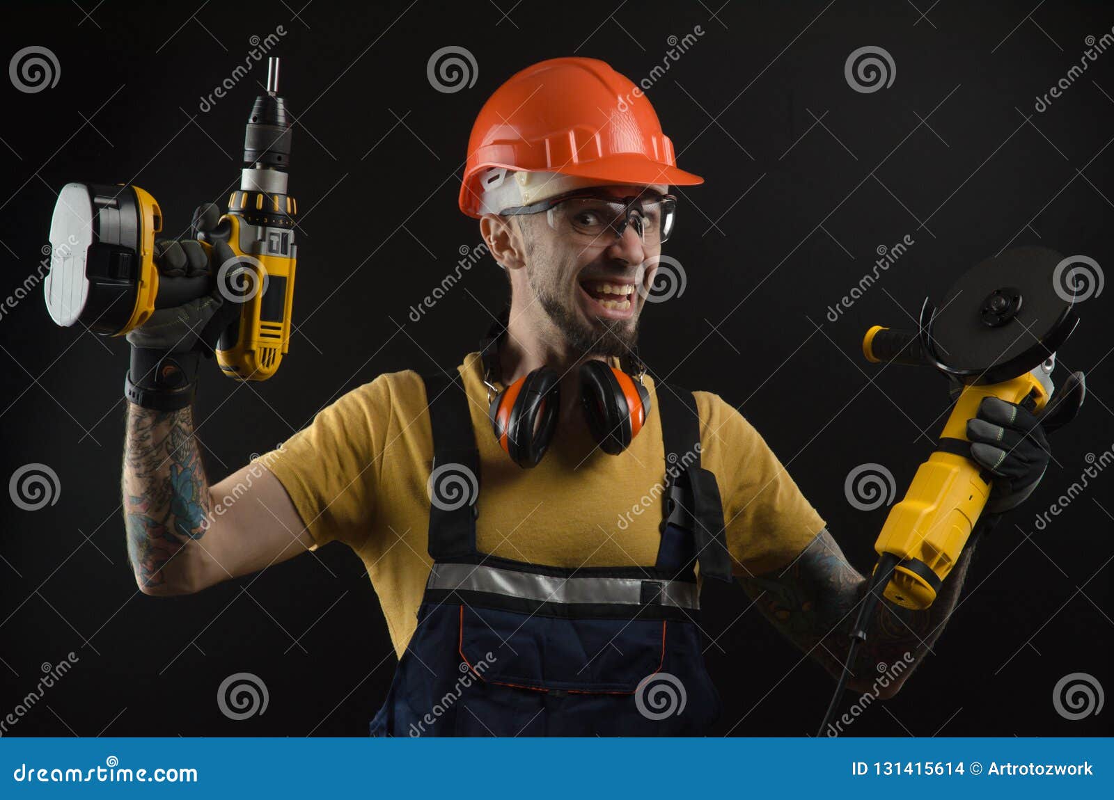 A Young Man Posing on a Black Background in a Work Uniform and a ...