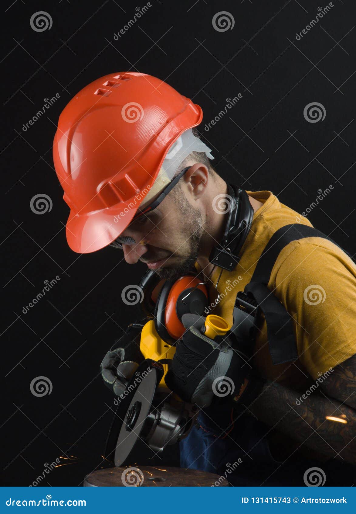 A Young Man Posing on a Black Background in a Work Uniform and a ...
