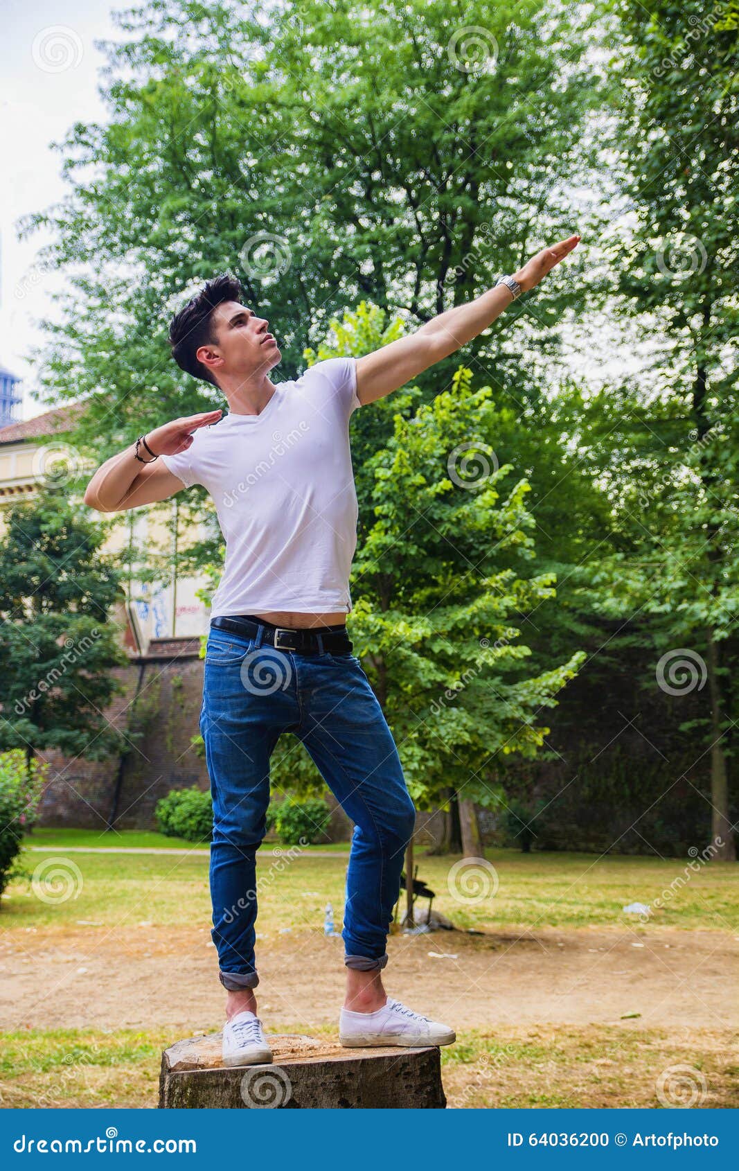 Young man posing on stump stock photo. Image of casual - 64036200