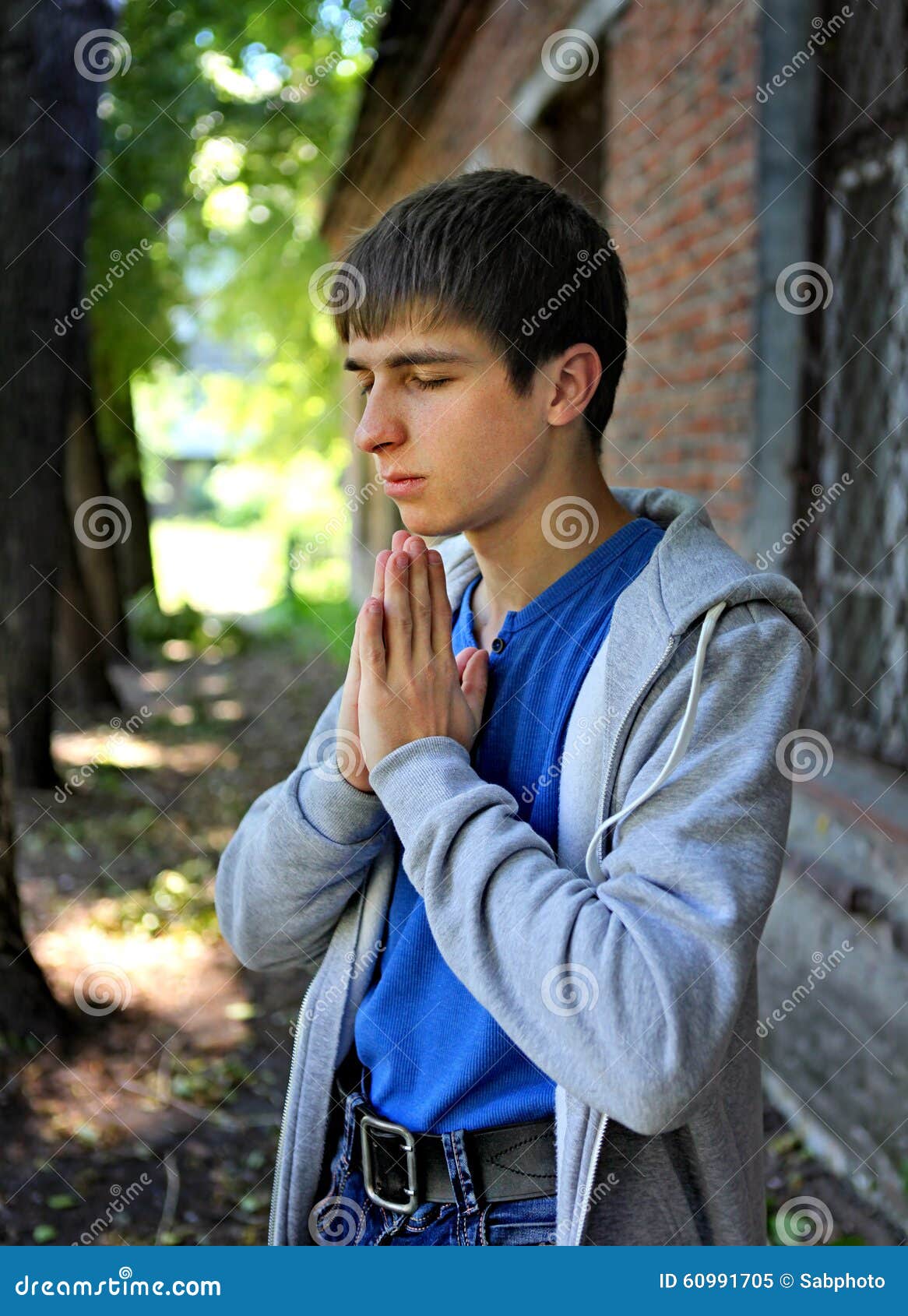 Young Man praying outdoor stock image. Image of pensive - 60991705
