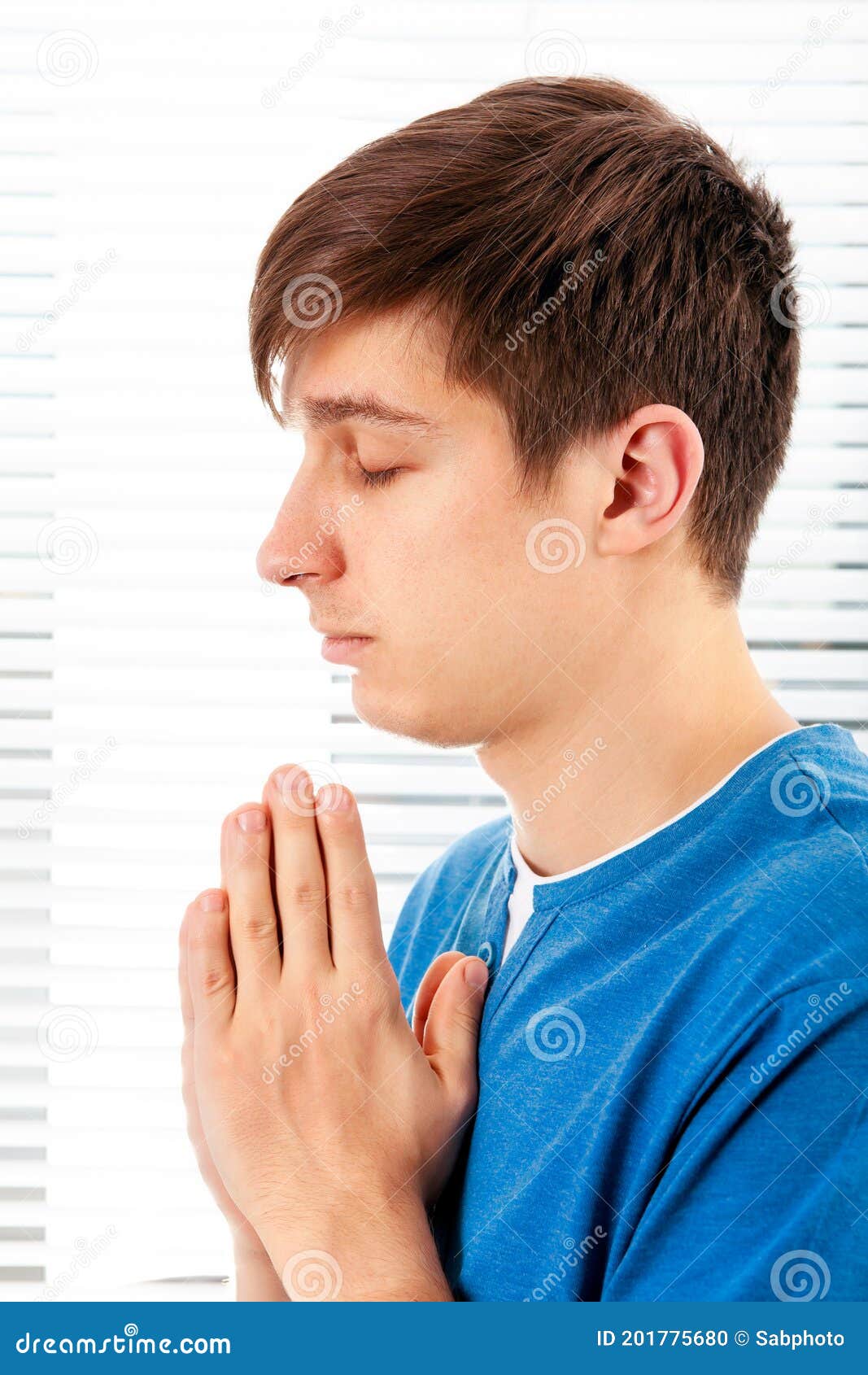 Young Man praying stock photo. Image of shirt, alone - 201775680
