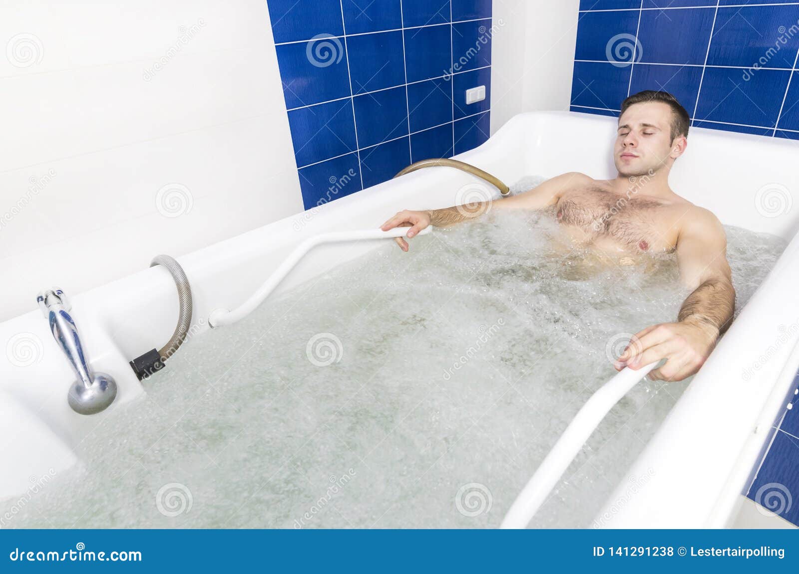 The Young Man is the Procedure in Whirlpool Hydrobath. Stock Photo ...