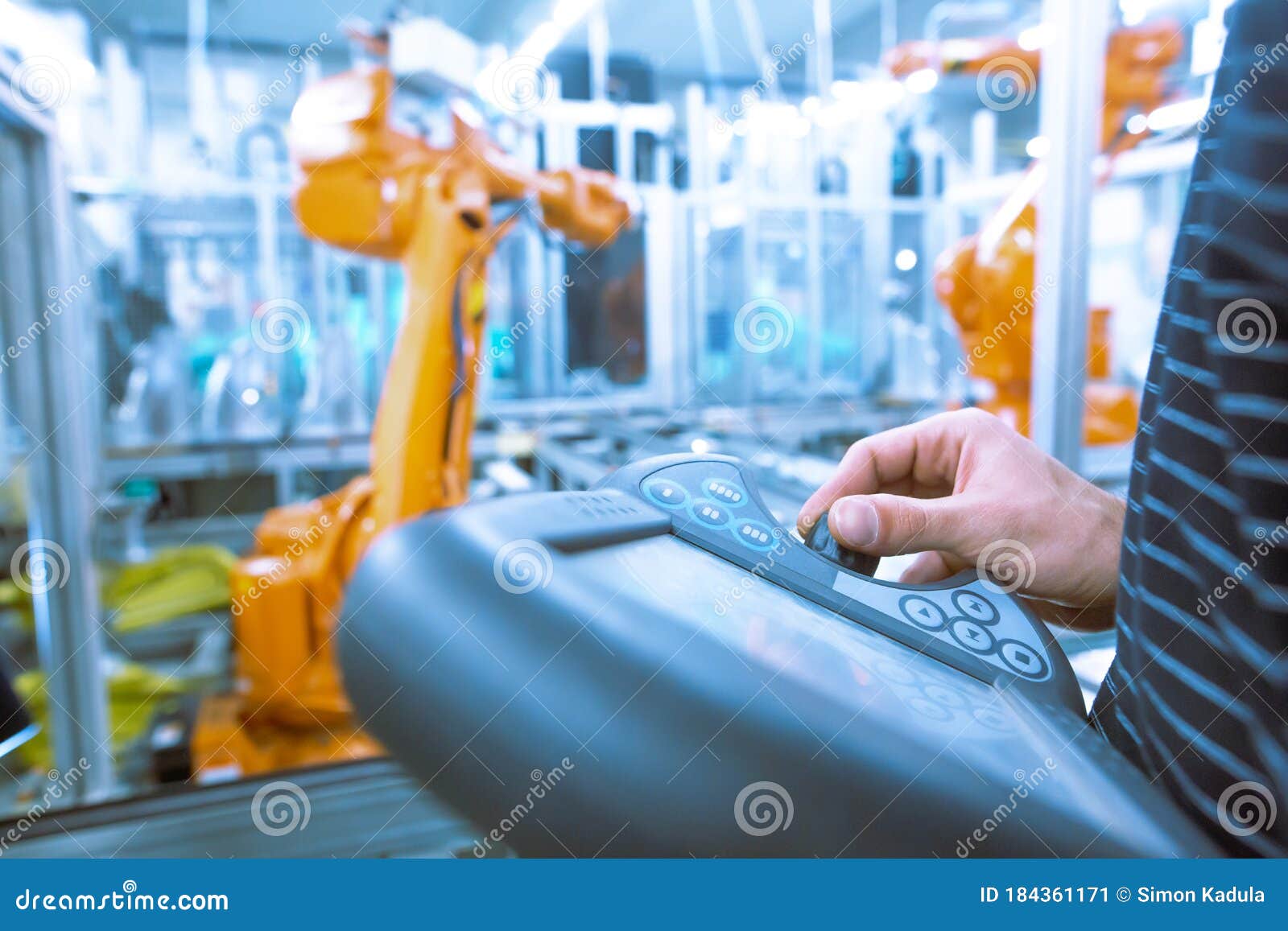 Young Man Programming Industrial Automatic Robot in the Automotive ...