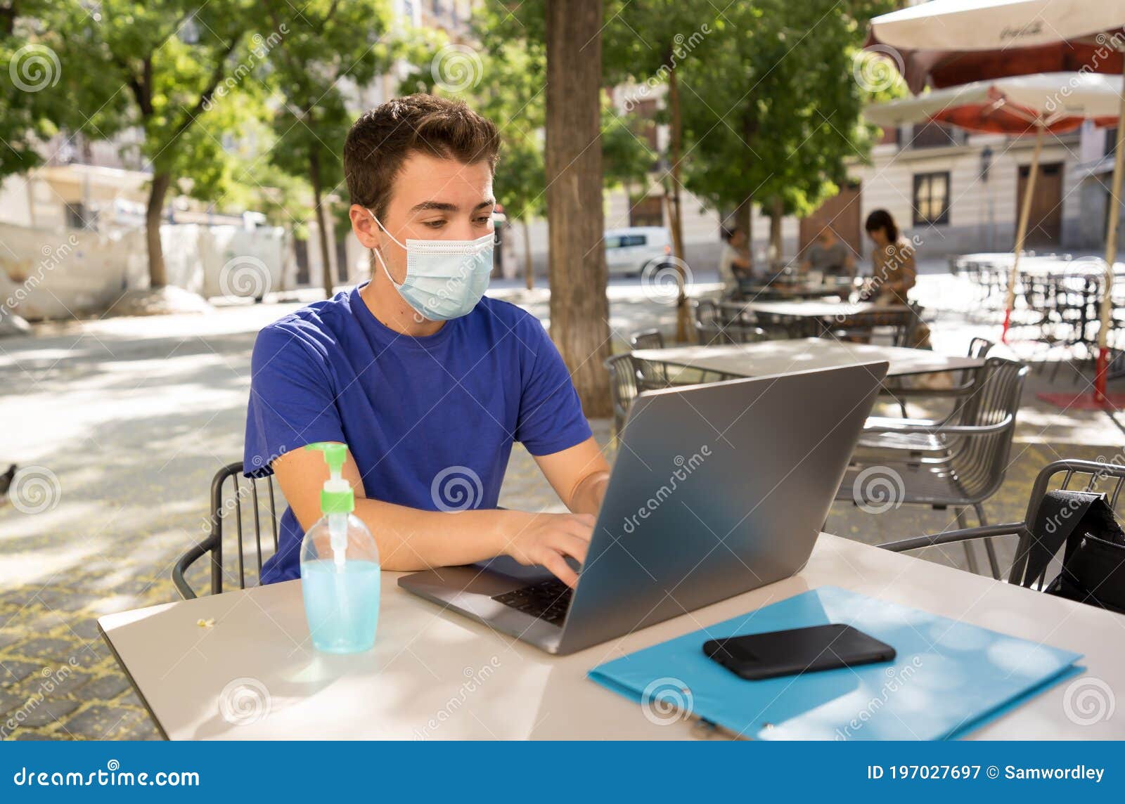 Young Man with Protective Face Mask and Hand Sanitizer Outdoors Working ...