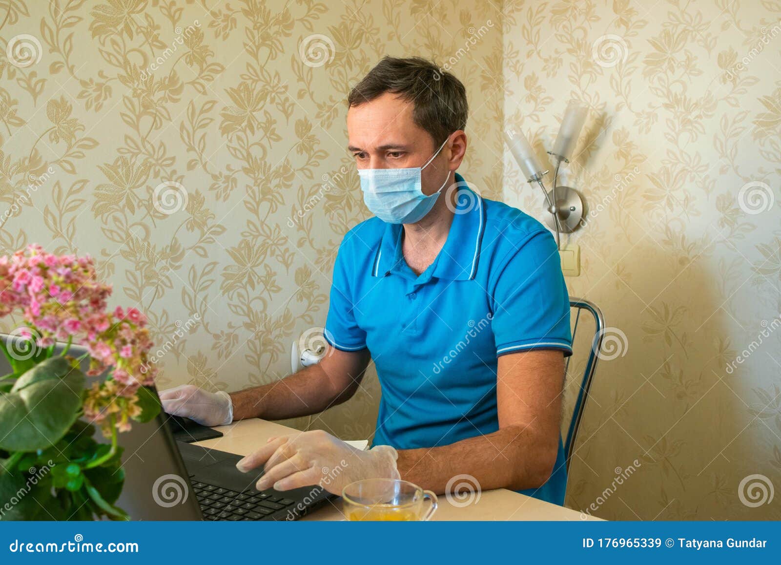 The Young Man in the Protective Mask and Gloves Works at the Computer ...