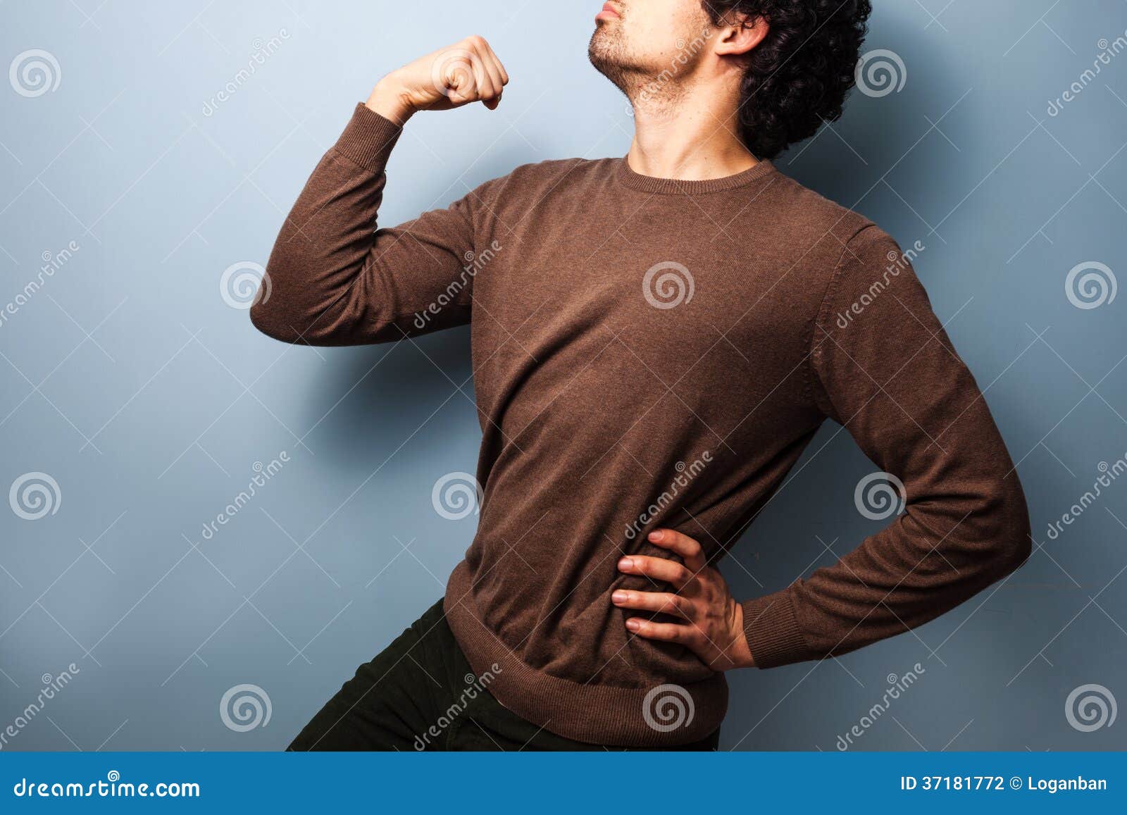 Young Man in Proud Stance with Fist Raised Stock Photo - Image of stern ...