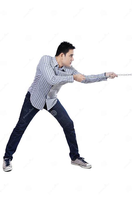 Young man pulling a chain stock image. Image of help - 34086843
