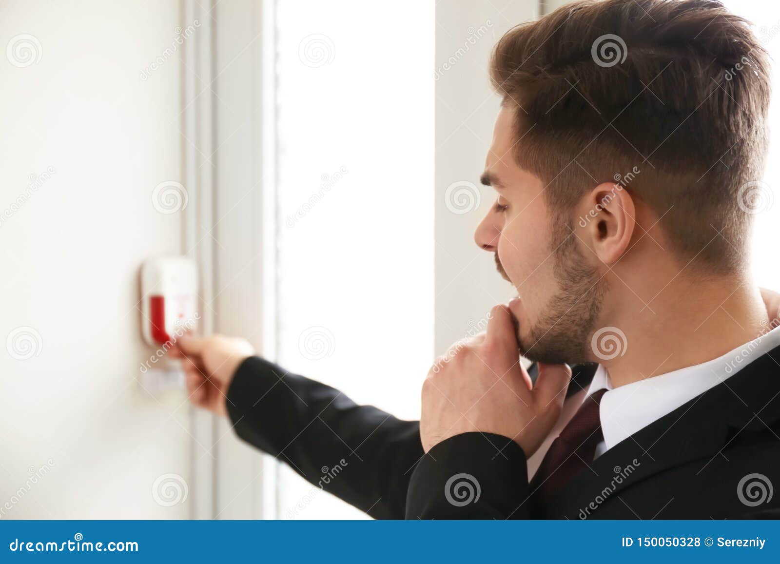 Young Man Pulling Handle of Fire Alarm Station, Indoors Stock Photo ...