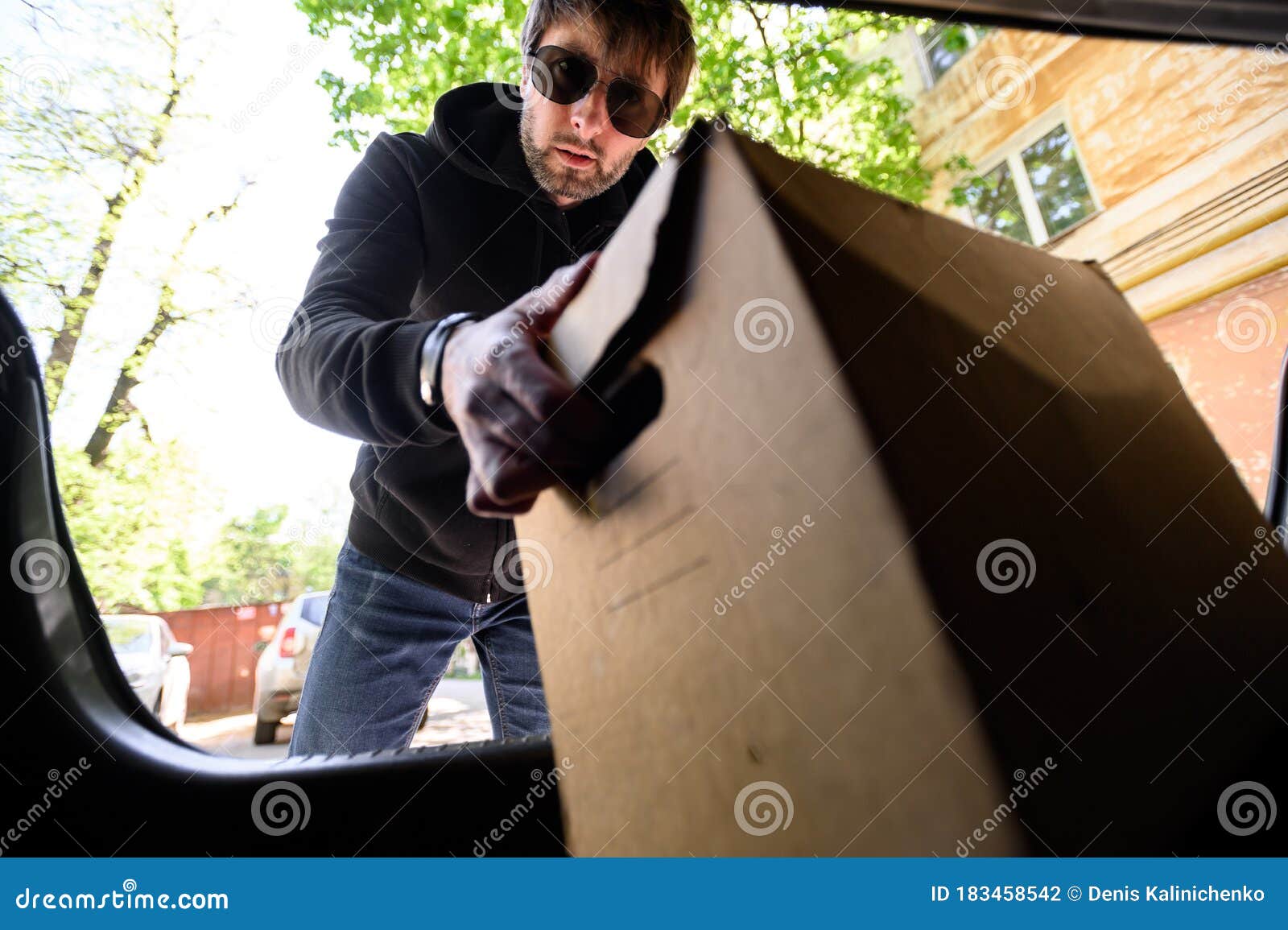 Young Man Puts a Box in the Car Stock Photo - Image of automobile ...