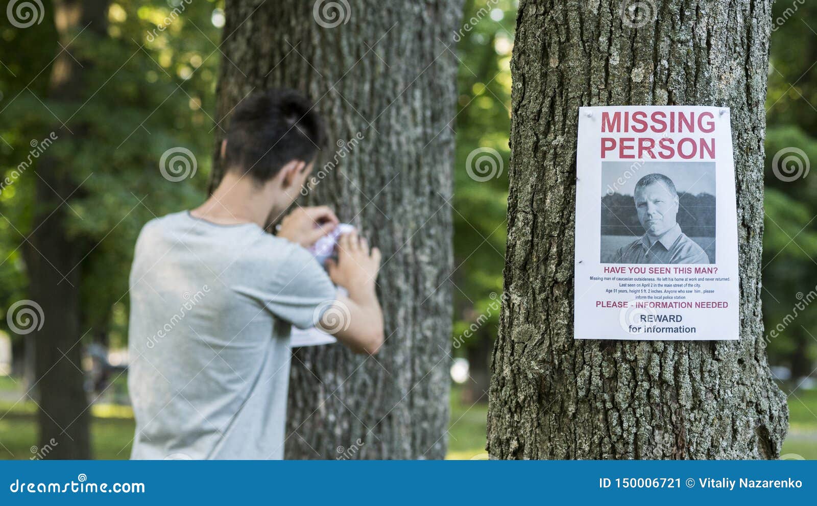 A Young Man Puts Up Ads for a Missing Person in the Park Stock Image ...