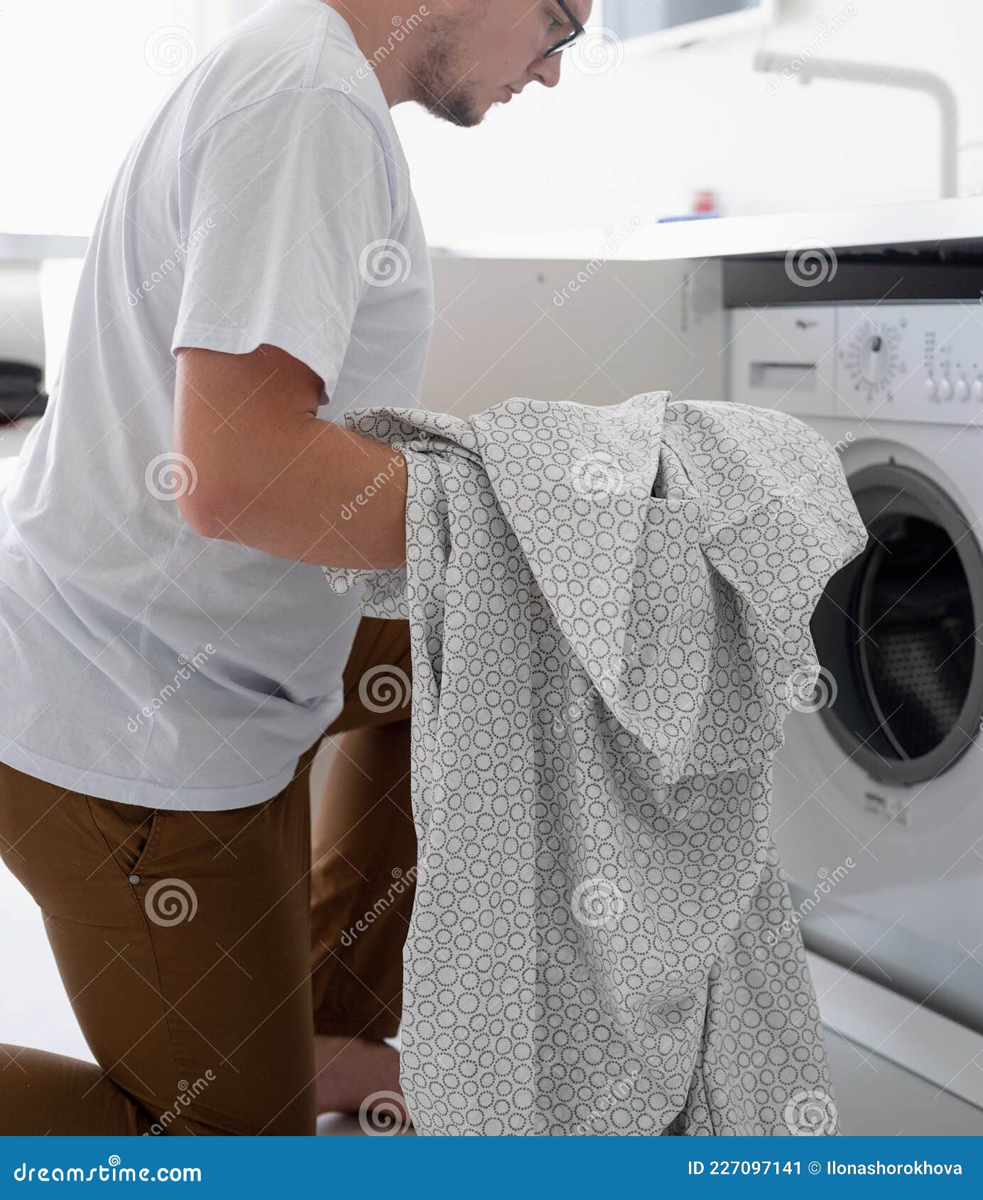 Young Man Putting Clothes into Washing Machine Stock Image - Image of ...