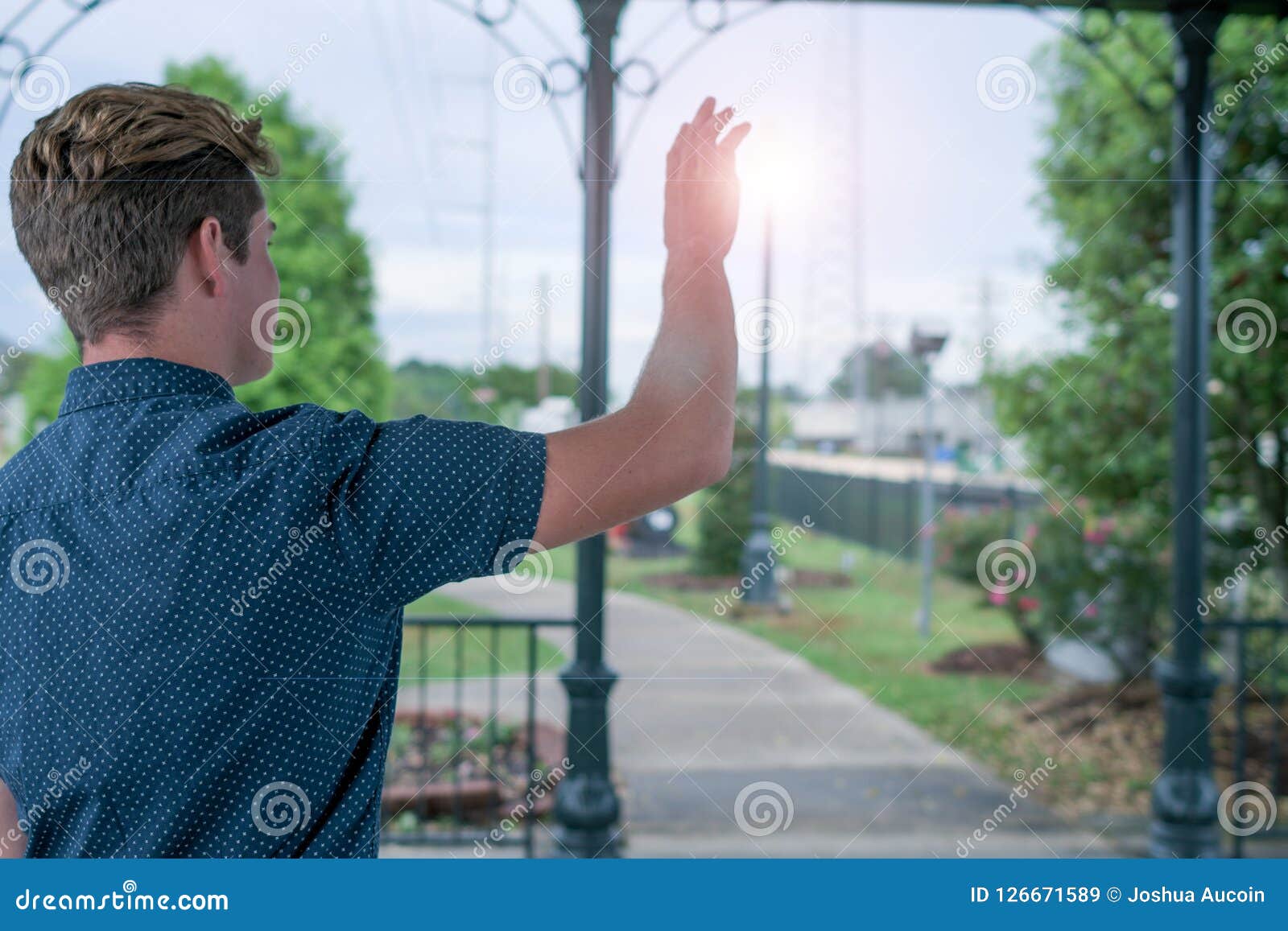 Young Man Reaches for a Ball of Light Stock Image - Image of lifestyle ...