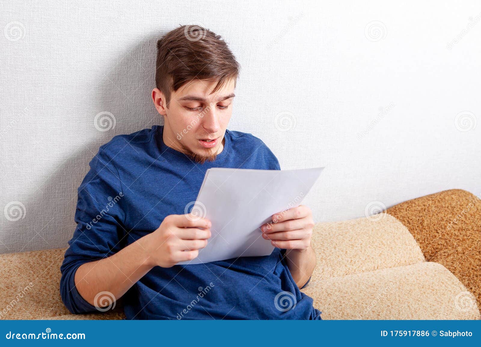 Young Man read a Document stock photo. Image of contract - 175917886