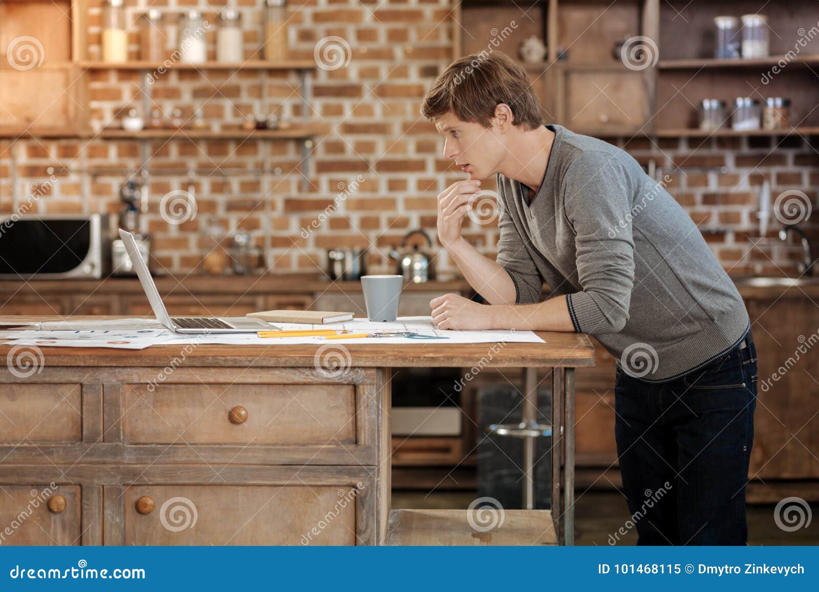 Young Man Reading Article on Laptop in the Kitchen Stock Image - Image ...