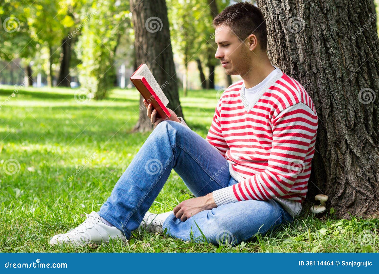 Young man reading a book stock photo. Image of close - 38114464