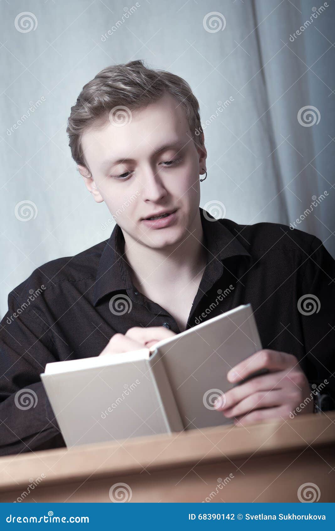 Young man reading a book stock photo. Image of research - 68390142