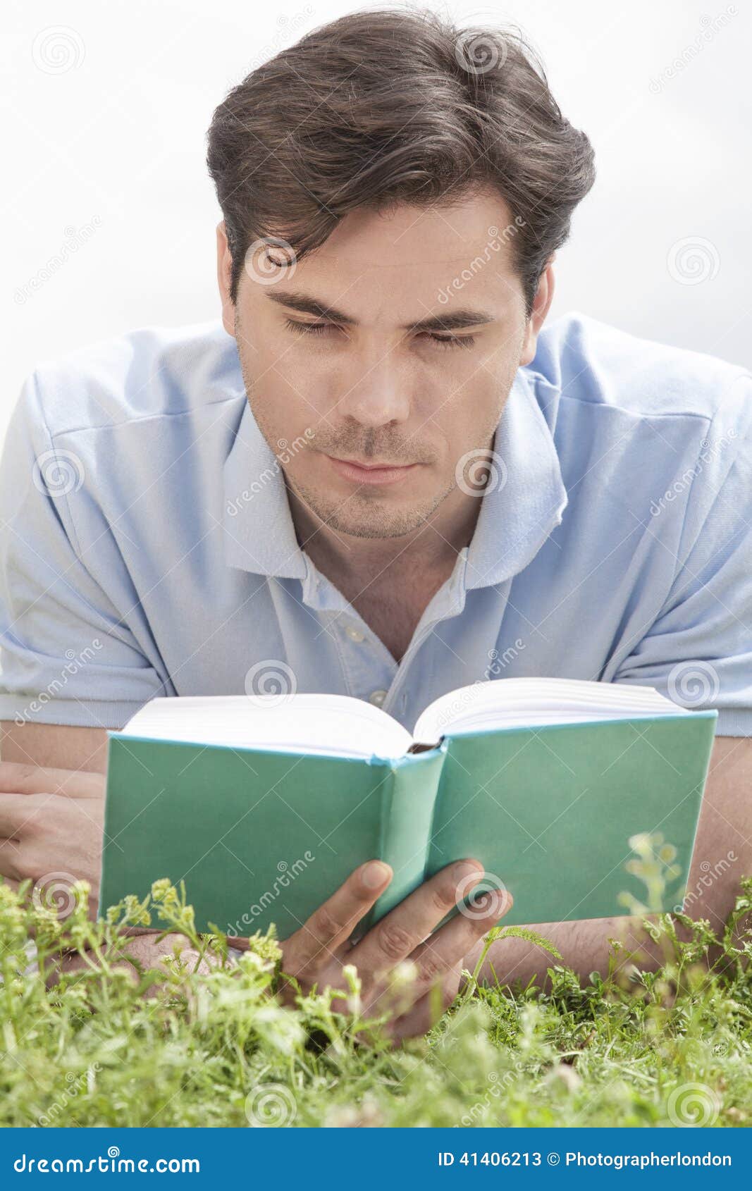 Young Man Reading Book on Grass Against Sky Stock Image - Image of ...