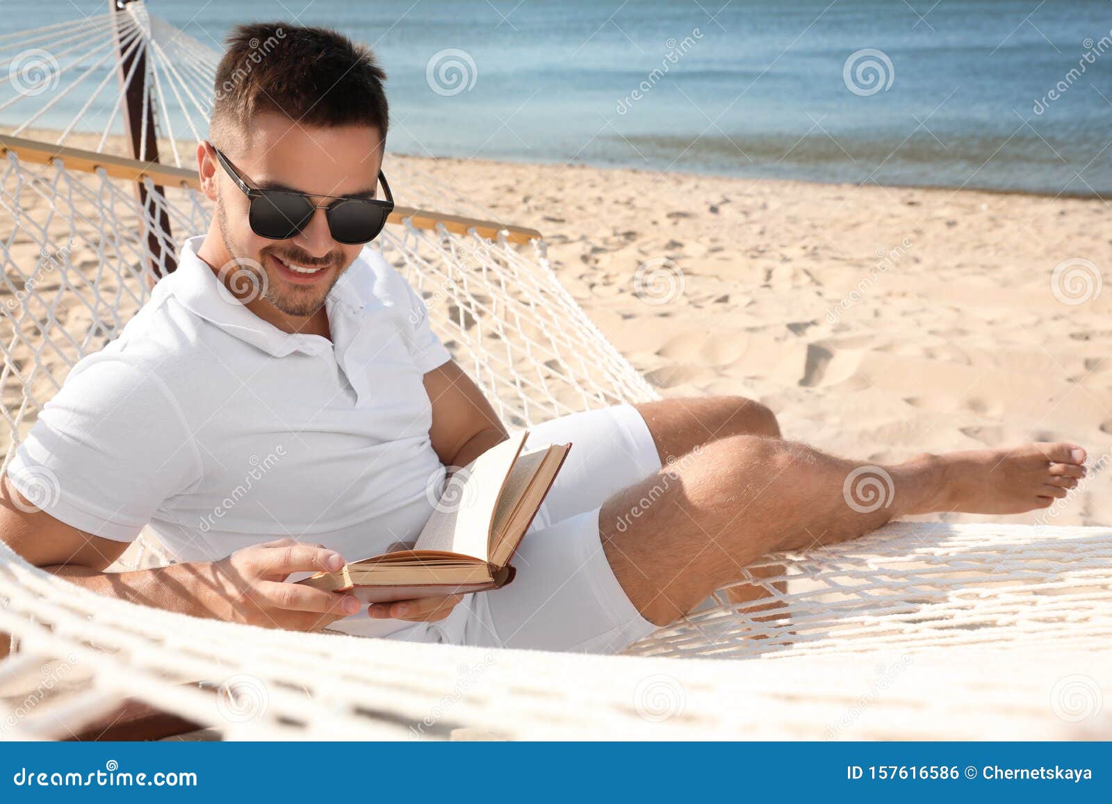 Young Man Reading Book in Hammock on Stock Photo - Image of relax ...