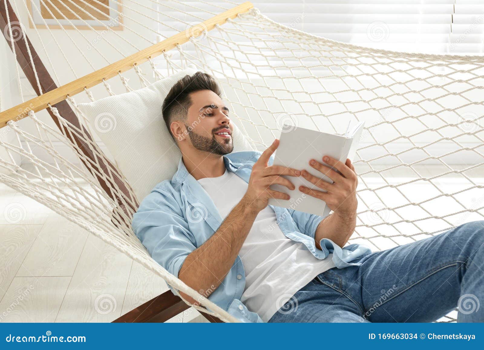 Young Man Reading Book in Hammock Stock Photo - Image of cozy, holiday ...