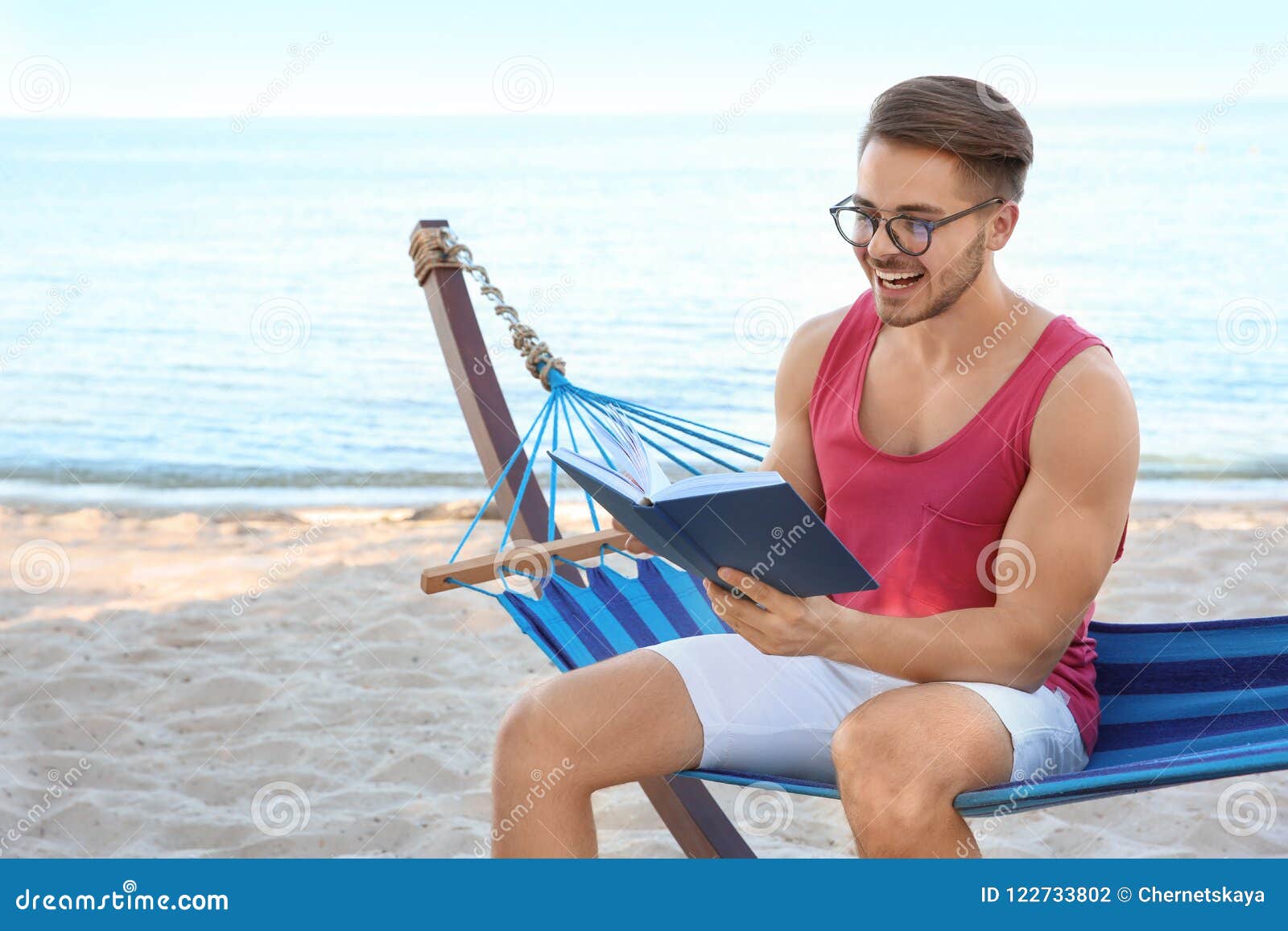 Young Man Reading Book in Hammock Stock Photo - Image of season, nature ...