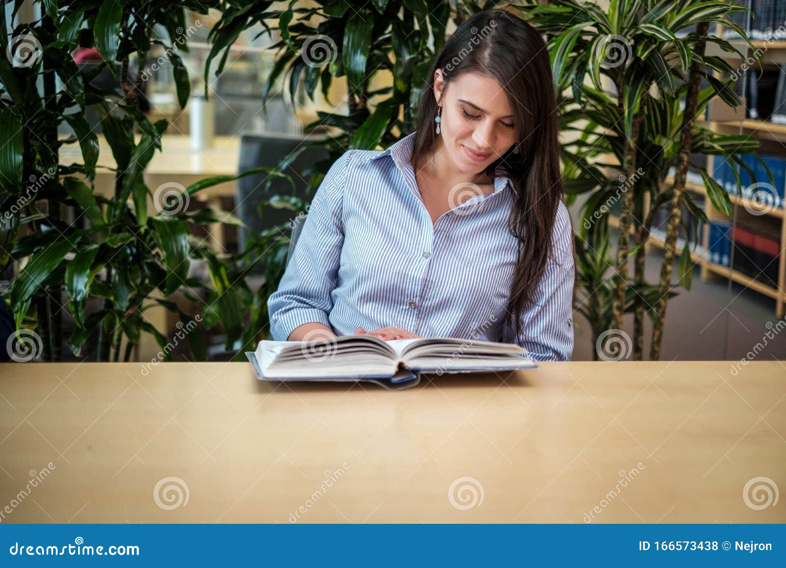 Young Man Reading Book in Public Library Stock Photo - Image of indoors ...