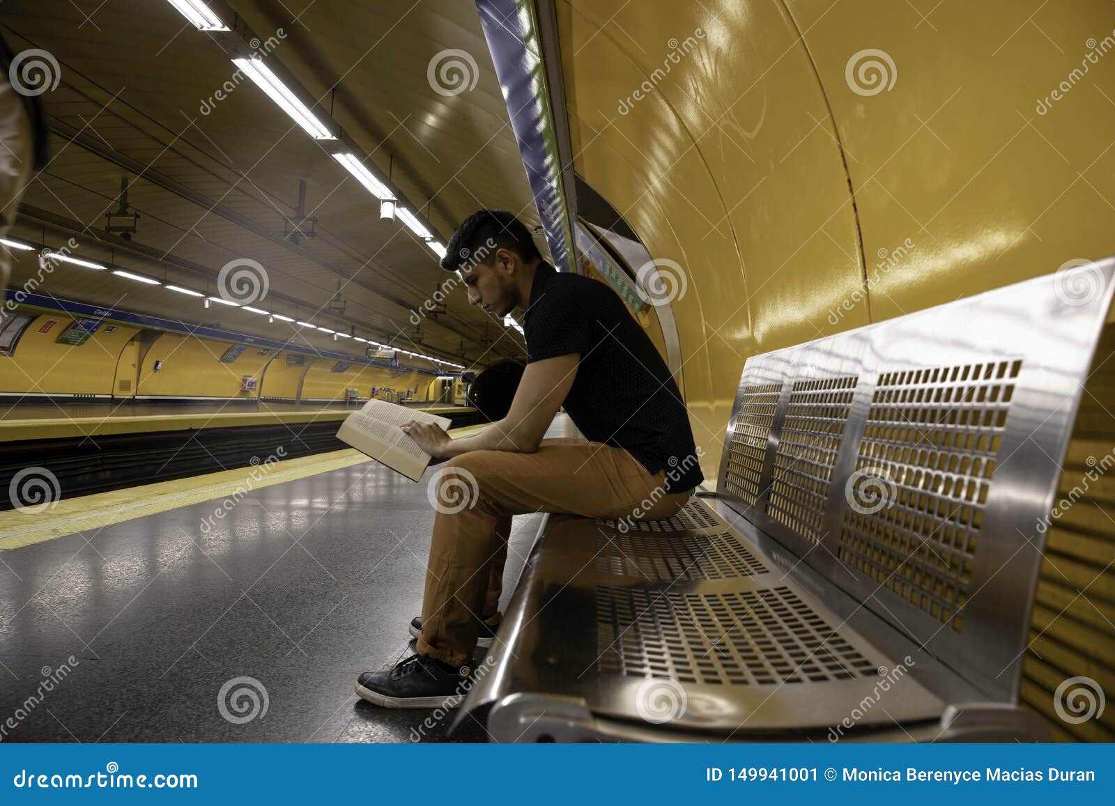 Young Man Reading a Book at the Subway Station Stock Image - Image of ...
